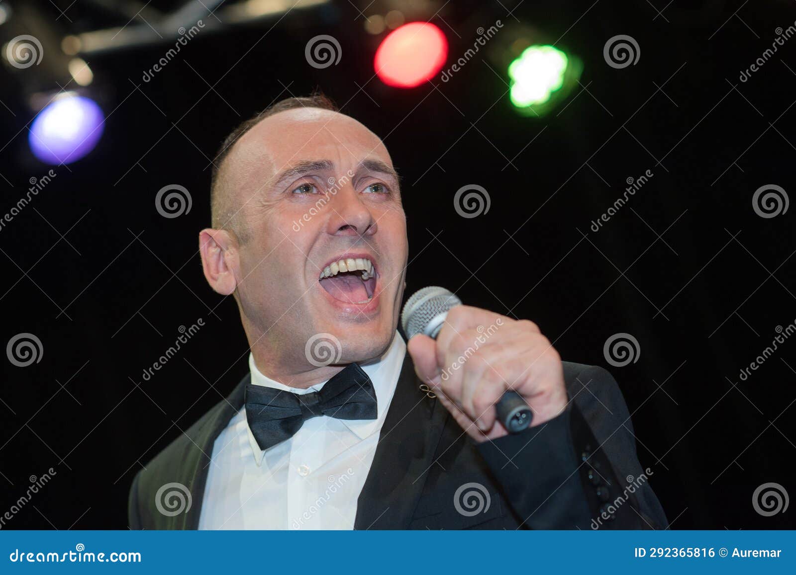 Man Singing on Stage Under Colored Lights Stock Photo - Image of ...