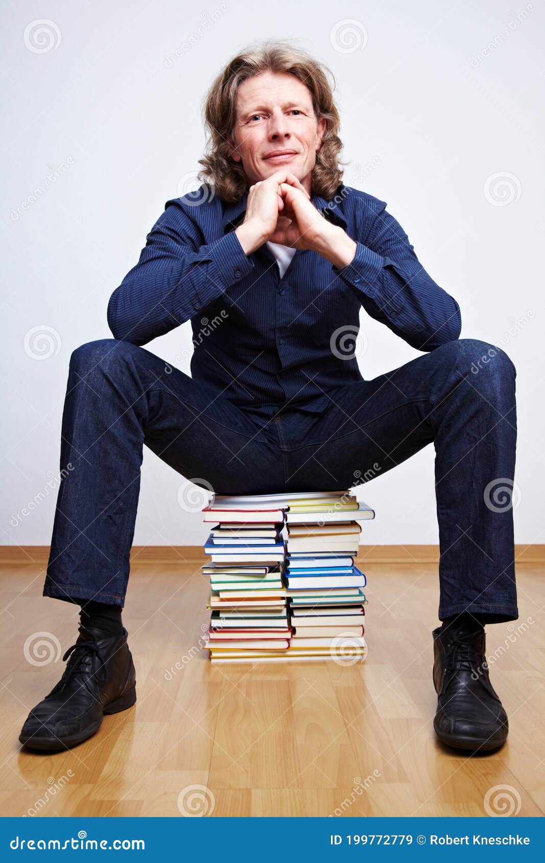 Man sits on books stock image. Image of smile, books - 199772779