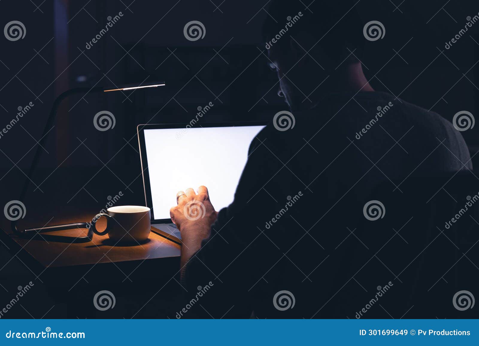 A Man Sits in a Dark Room in Front of a Blank Laptop Screen. Stock ...