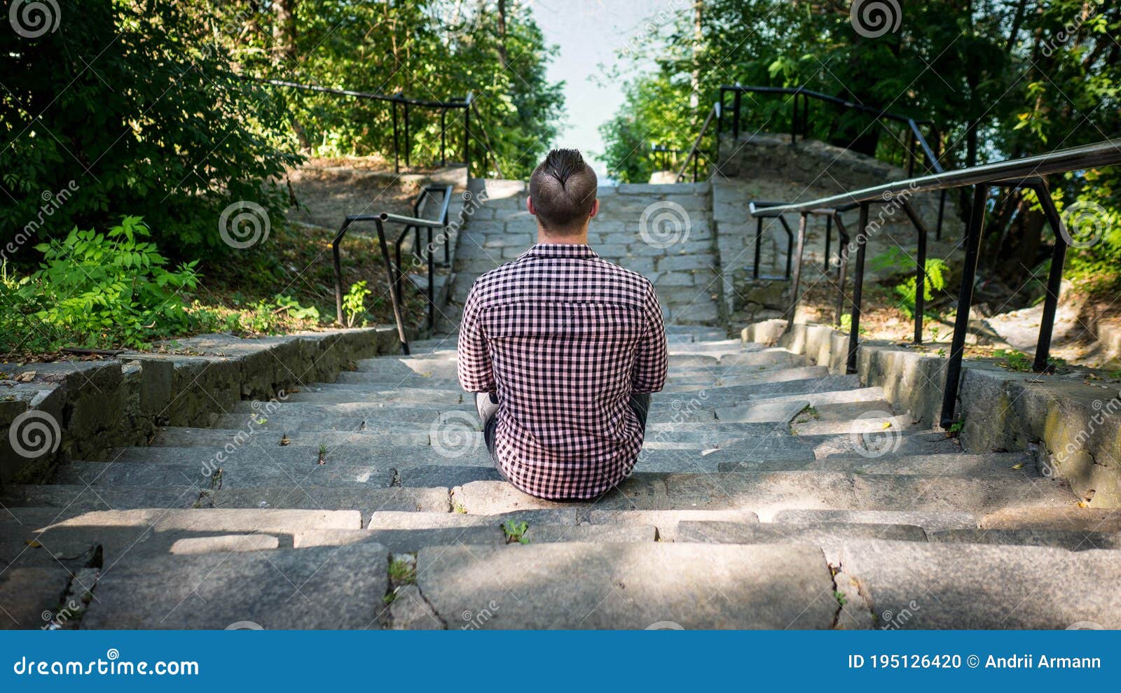 A Man Sits on the Steps and Thinks about Something,a Sad Guy in a Park ...