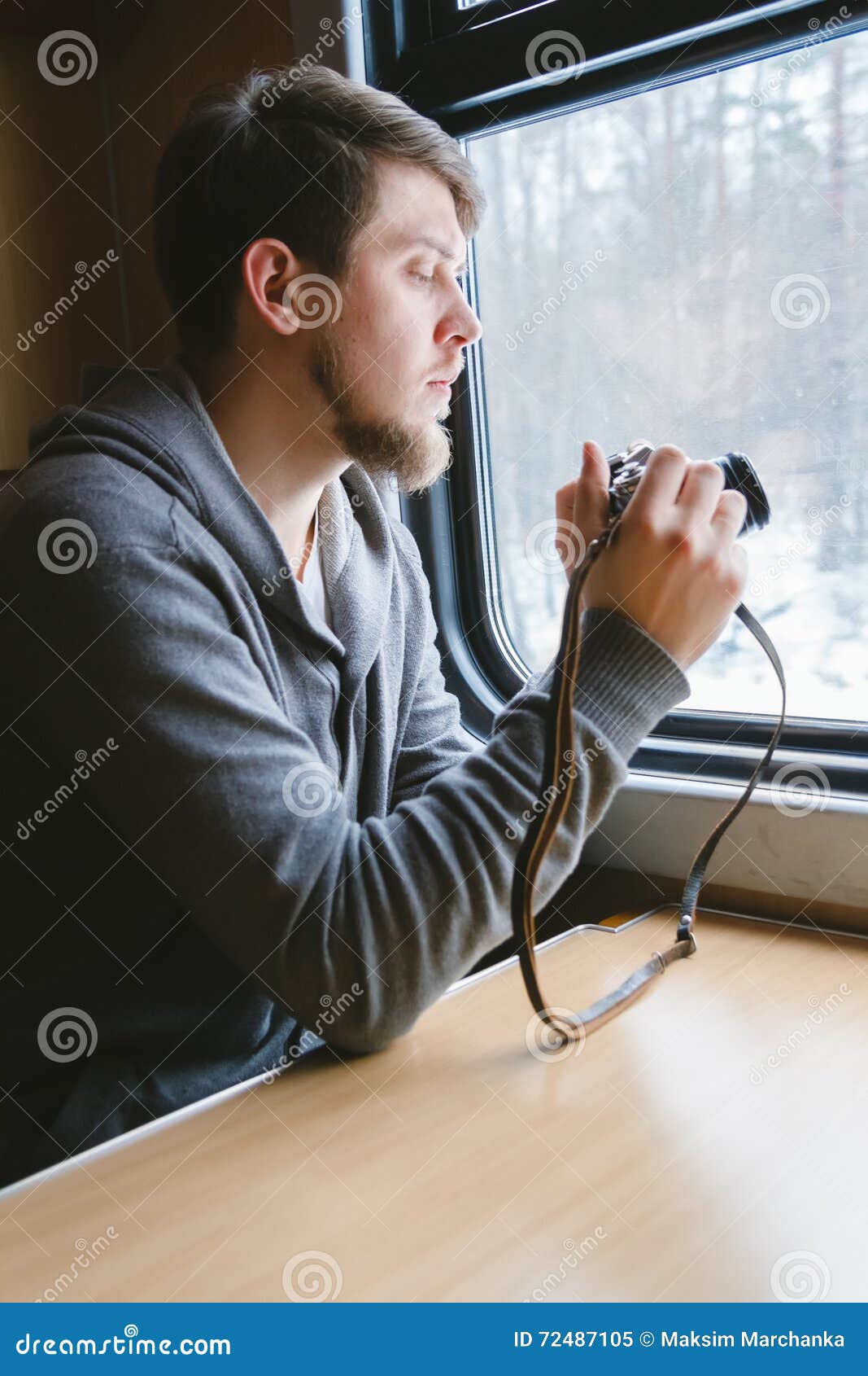 Man Sits at a Table in a Train with a Camera Stock Image - Image of ...