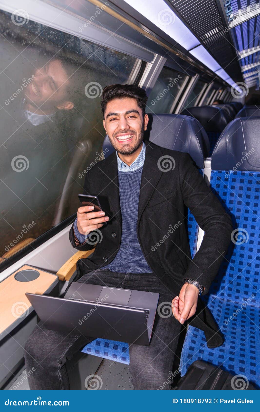 Man Sits in Train with Notebook and Phone in Hand Stock Photo - Image ...