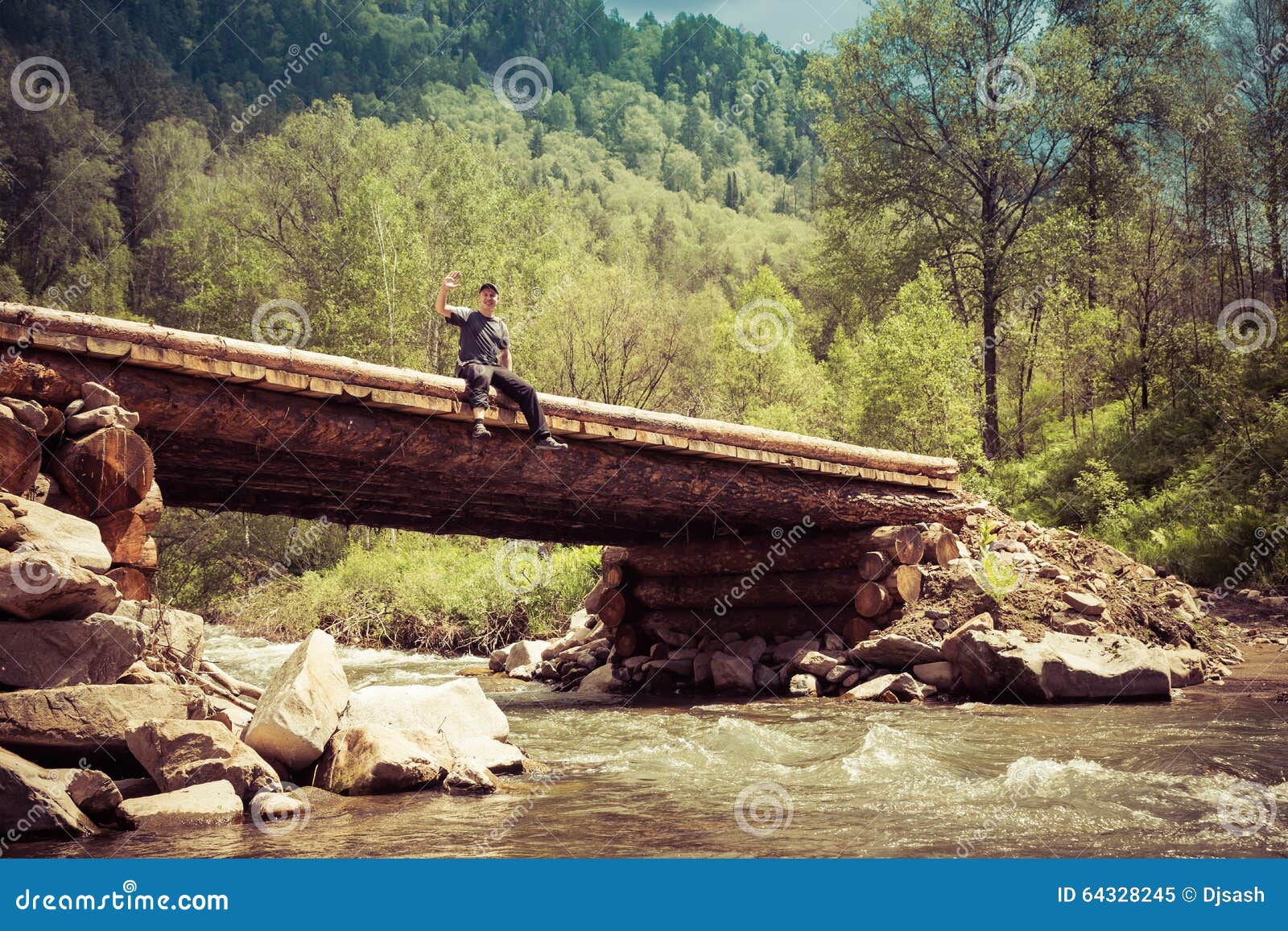 Man Sits on a Wooden Bridge Stock Image - Image of bridge, scene: 64328245