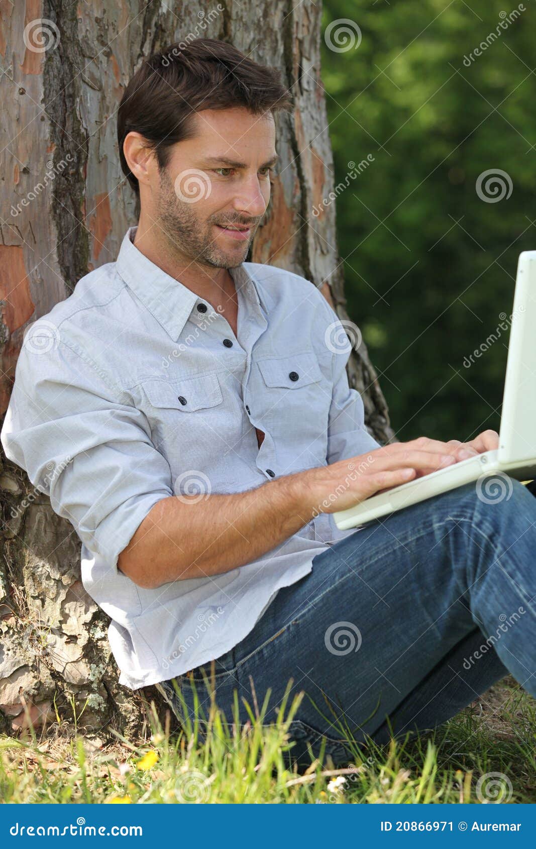 Man sitting against a tree stock image. Image of wellness - 20866971
