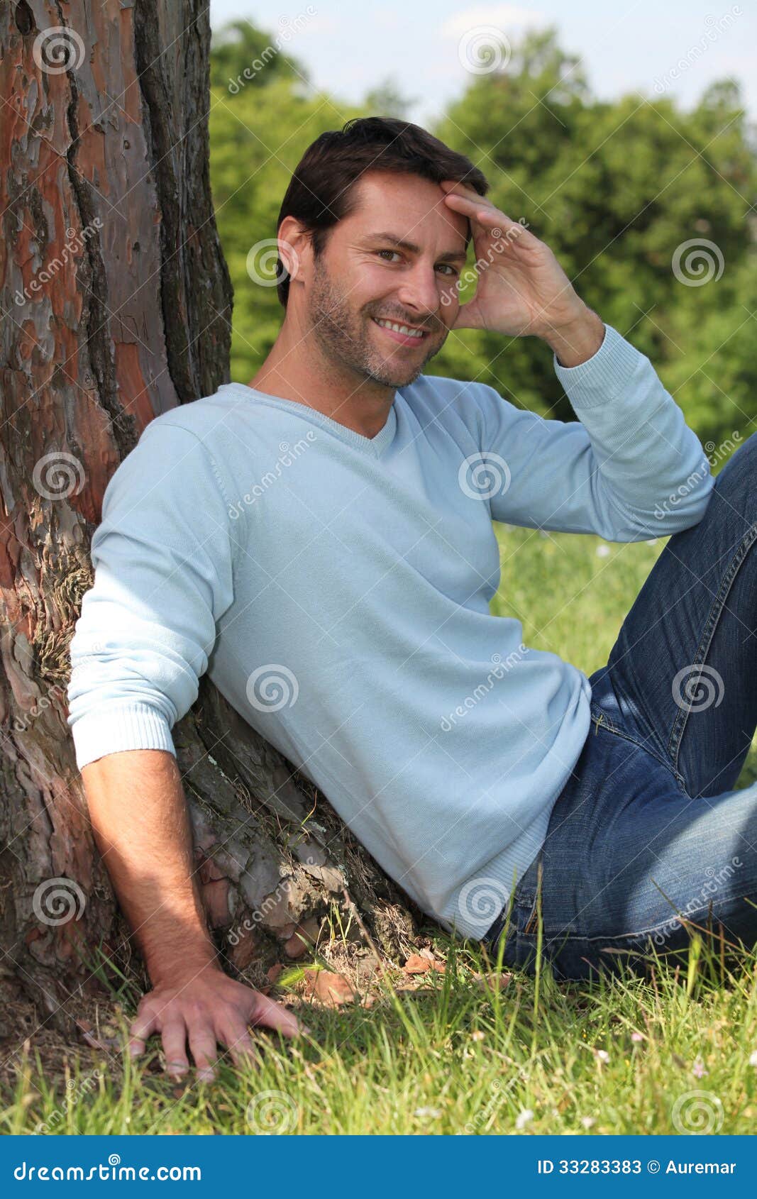 Man sitting against tree stock image. Image of landscape - 33283383