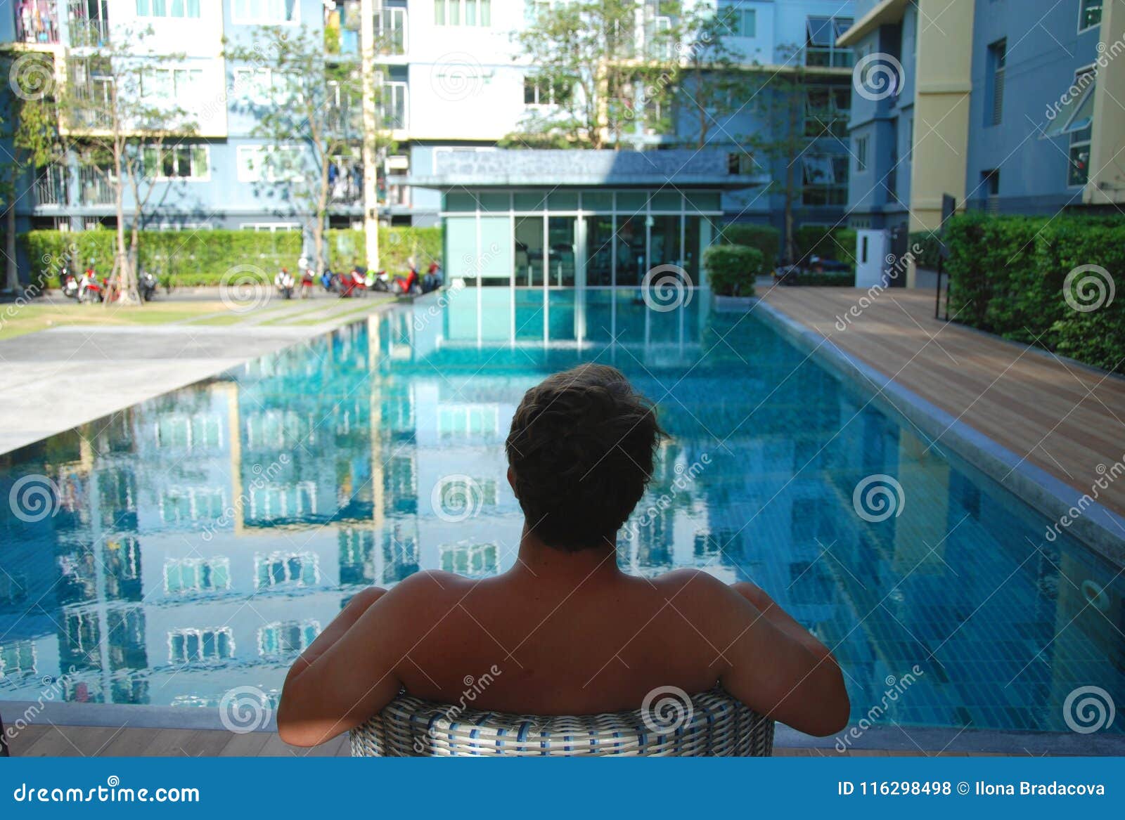 A man by swimming pool stock photo. Image of back, swim - 116298498