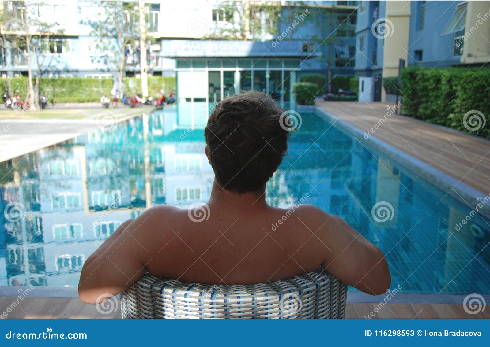 A man by swimming pool stock image. Image of resort - 116298593