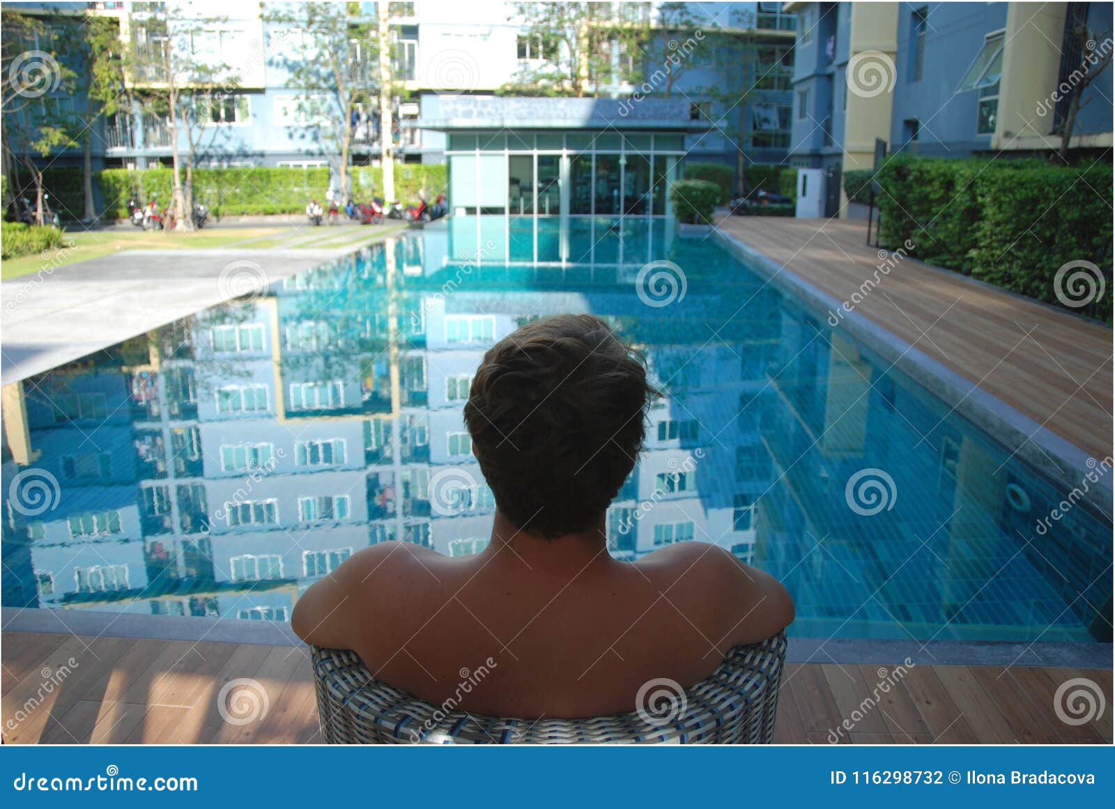 A man by swimming pool stock photo. Image of turquoise - 116298732