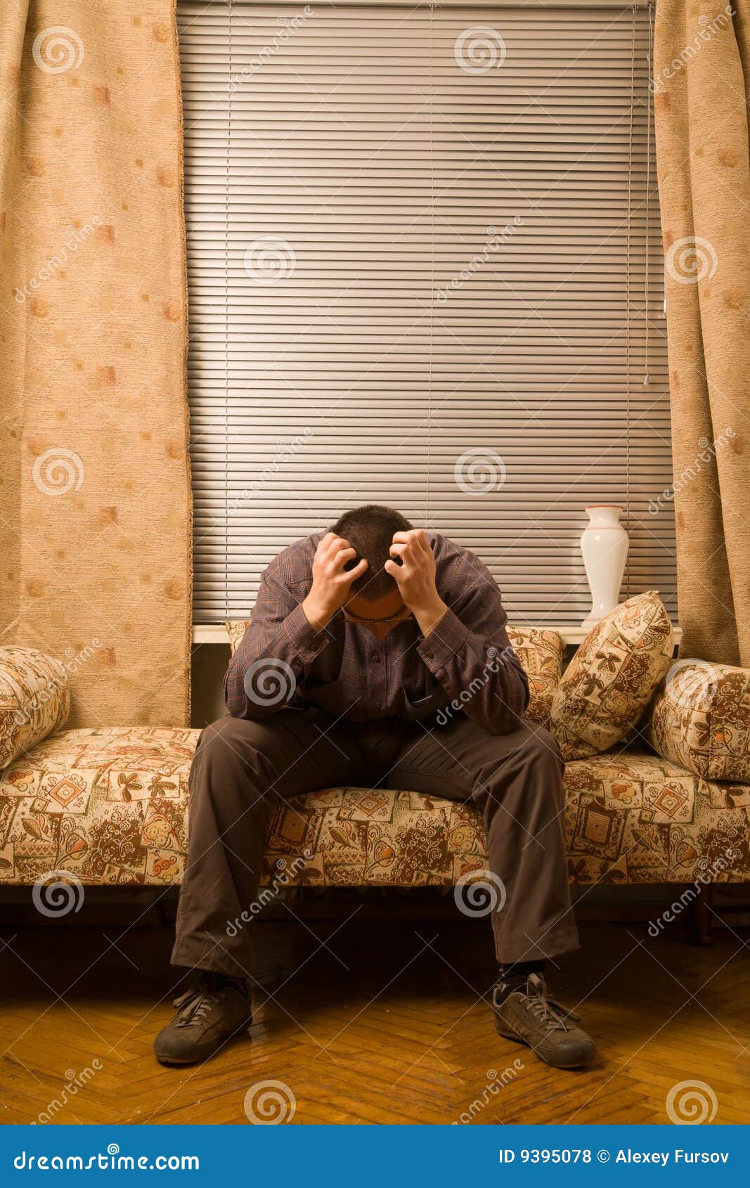 Man Sitting Alone on the Sofa Stock Photo - Image of clasp, interior ...