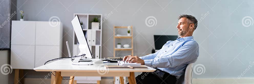 Man Sitting in Bad Posture Working on Computer Stock Photo - Image of ...