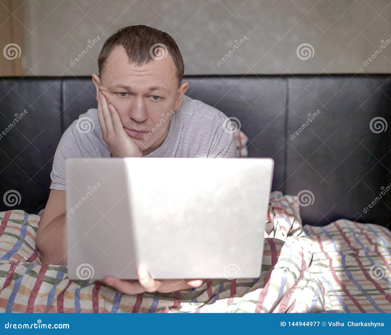 Man Sitting in Bed Under the Covers with a Laptop Stock Image - Image ...