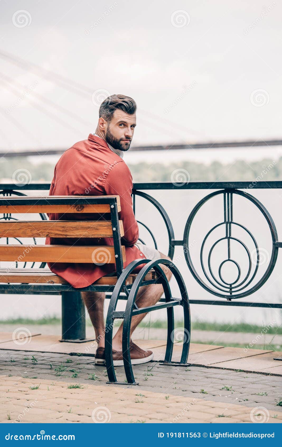 Man Sitting on Bench and Looking at Camera Stock Image - Image of ...