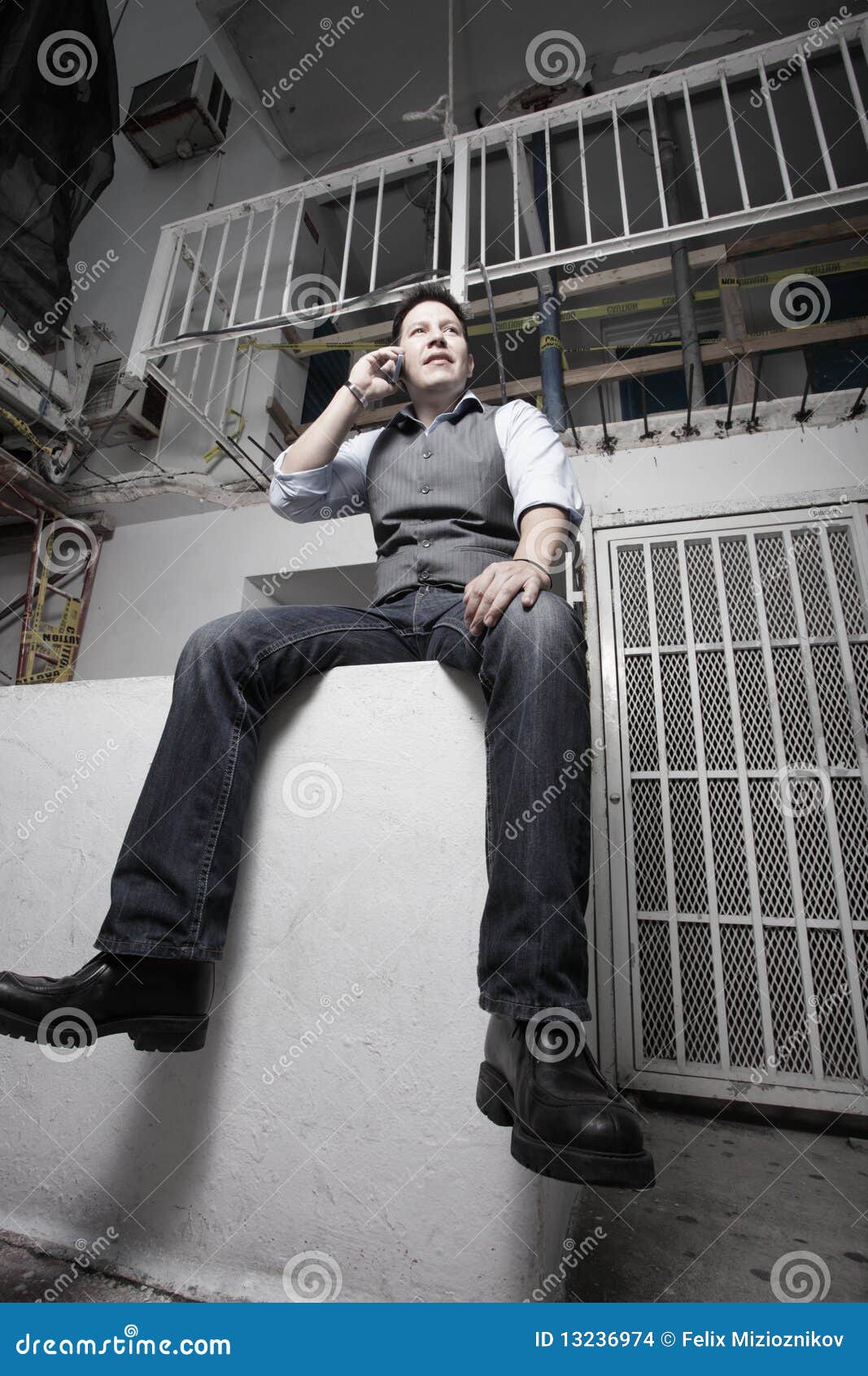 Man Sitting by a Building Under Construction Stock Photo - Image of ...
