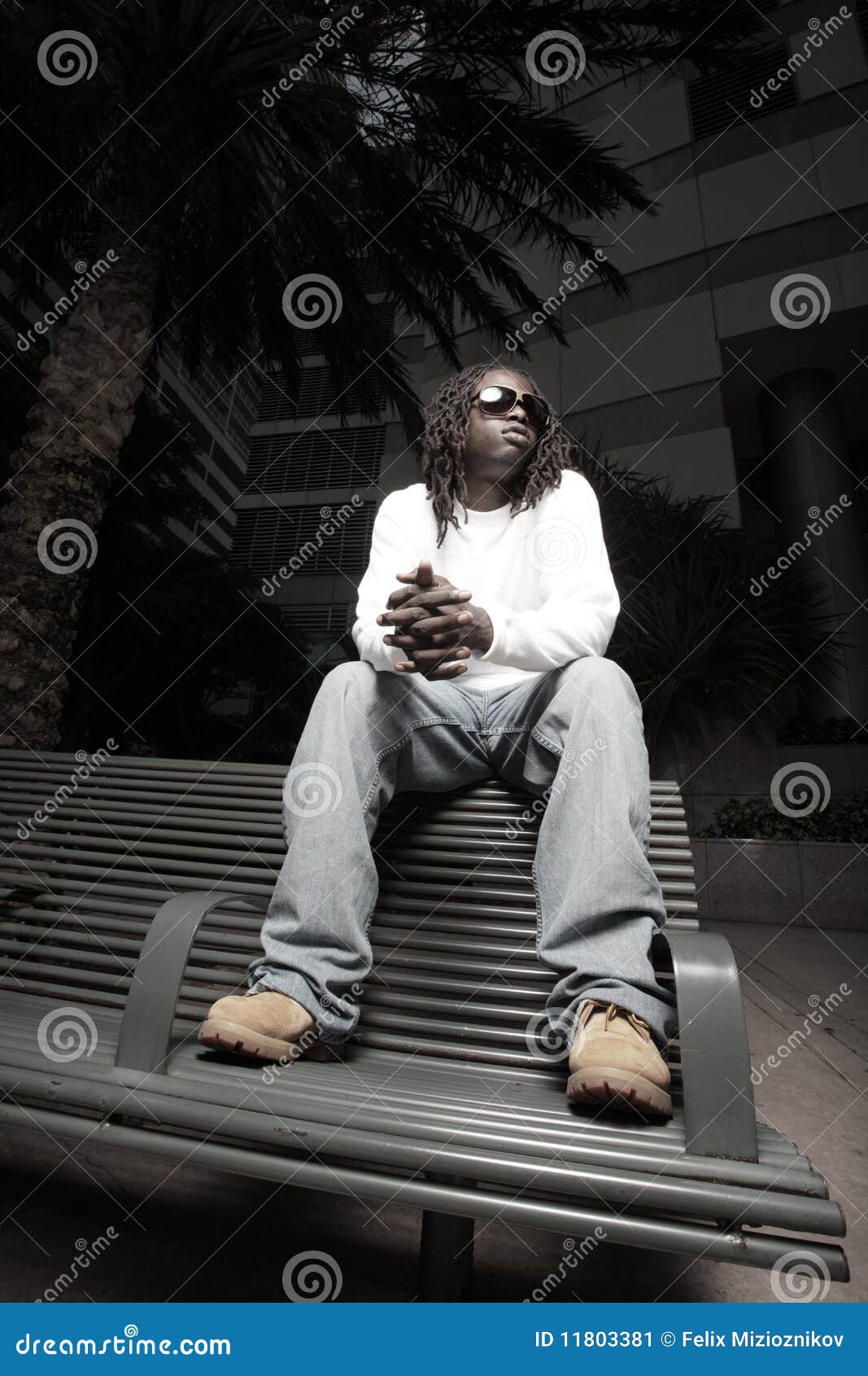 Man Sitting on a Bus Bench at Night Stock Image - Image of modern ...