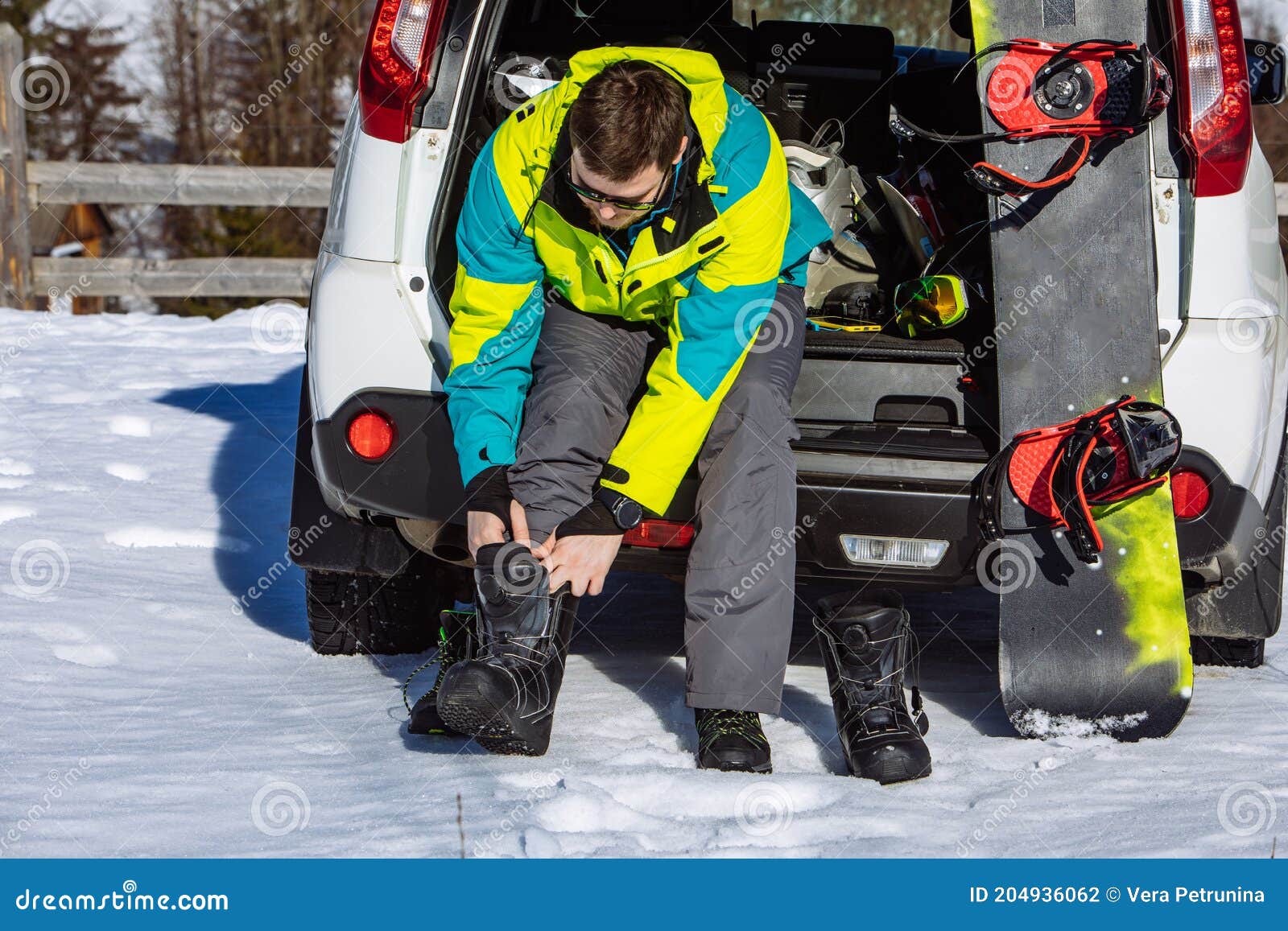 Man Sitting in Car Trunk Changing for Snowboard Stock Photo - Image of skiing, cold: 204936062