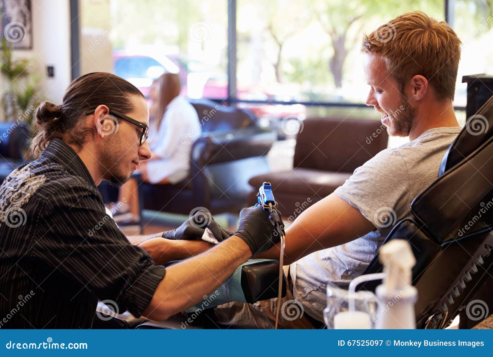 Man Sitting in Chair Having Tattoo on Arm in Parlor Stock Image - Image ...