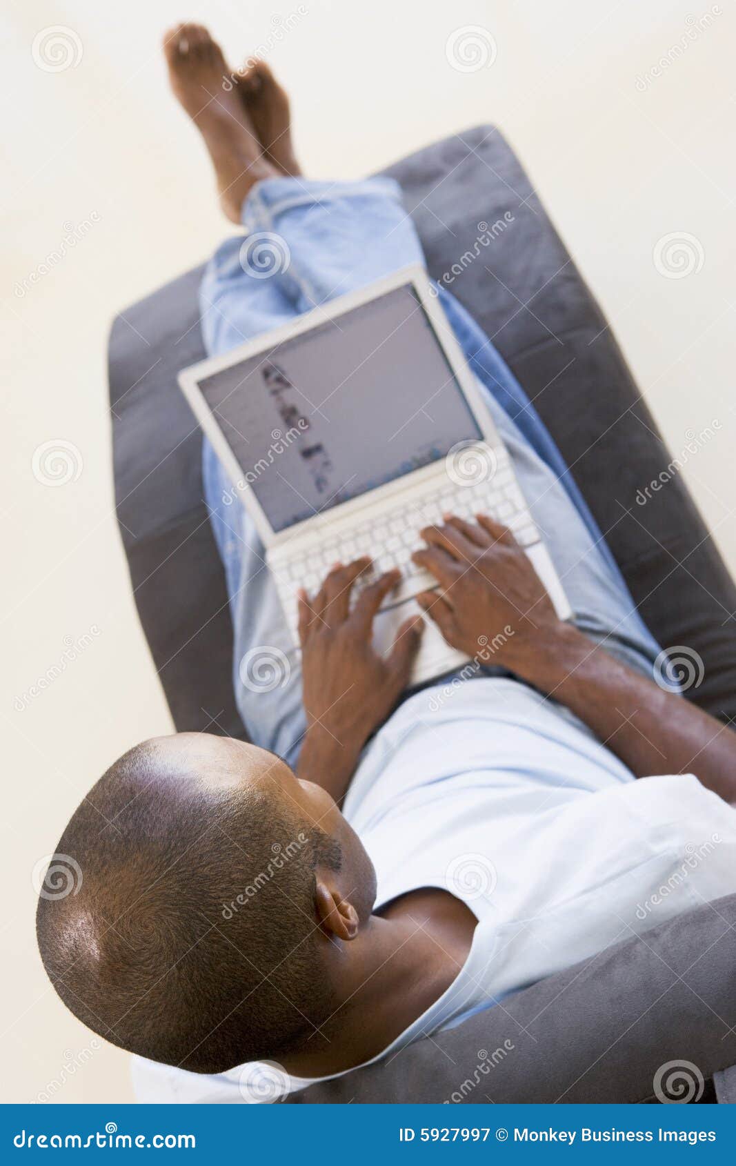 Man Sitting in Chair Using Laptop Stock Image - Image of american ...