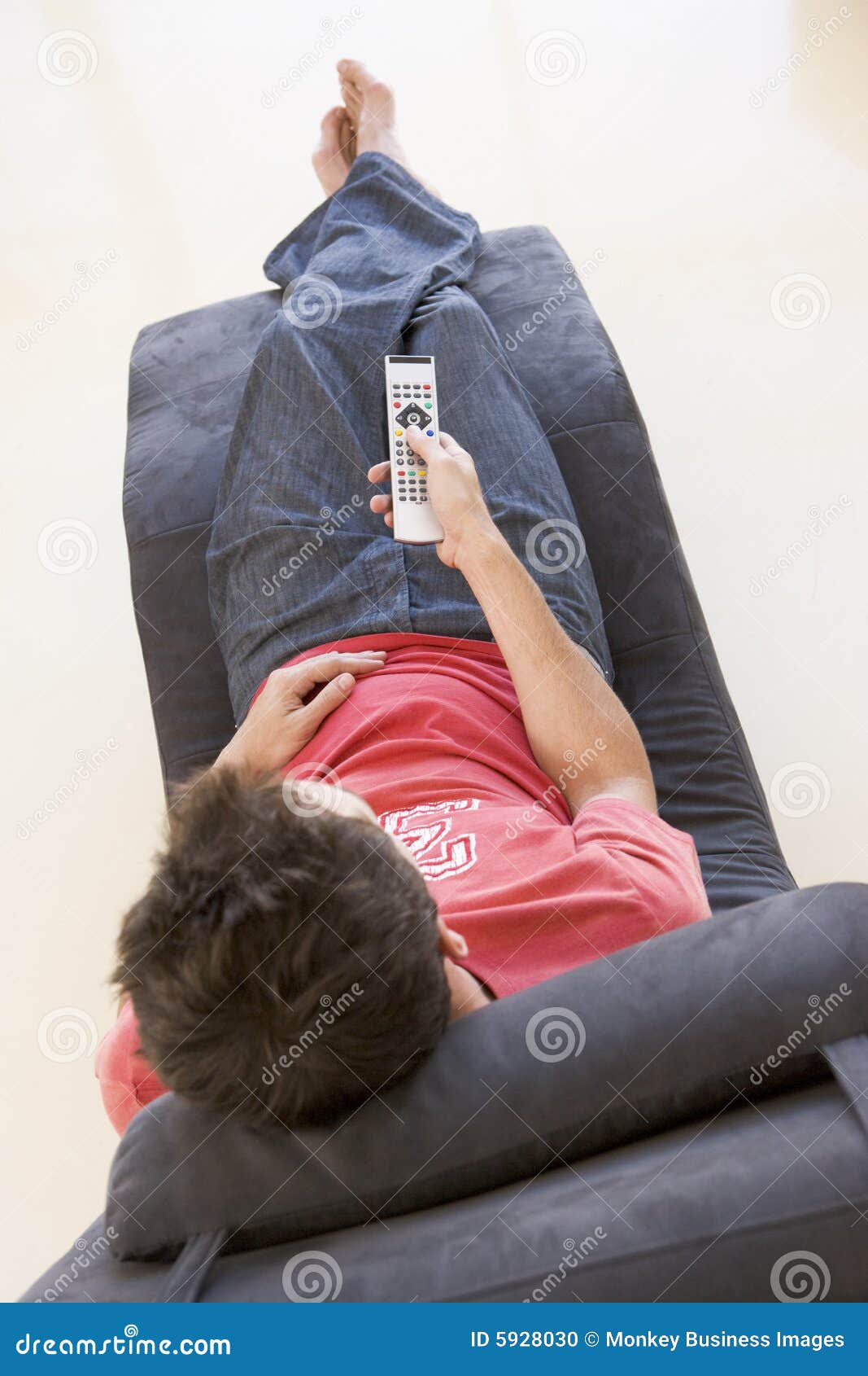 Man Sitting in Chair Using Remote Control Stock Photo - Image of ...