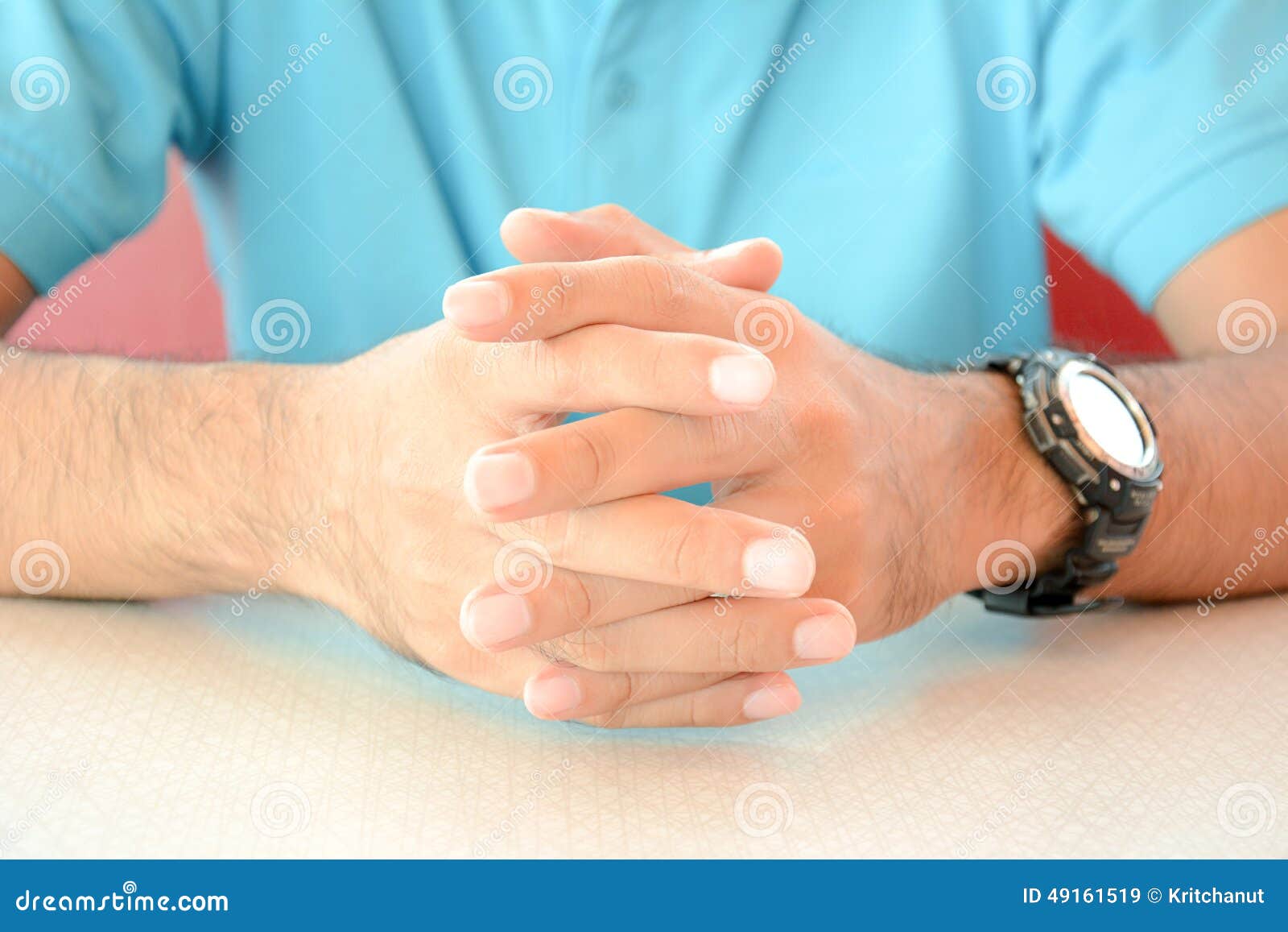 A Man Sitting with Clasped Hands on the Table Stock Image - Image of ...