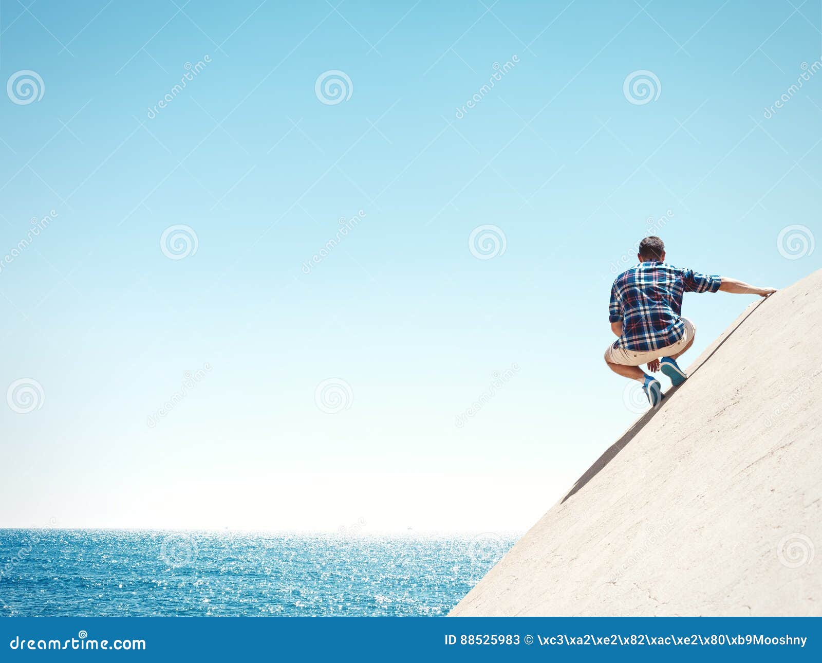 Man Sitting on a Cliff and Sea Stock Image - Image of alone, adventure ...