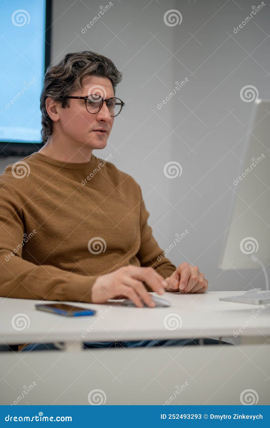 A Man Sitting at the Computer and Looking Concentrated Stock Image ...