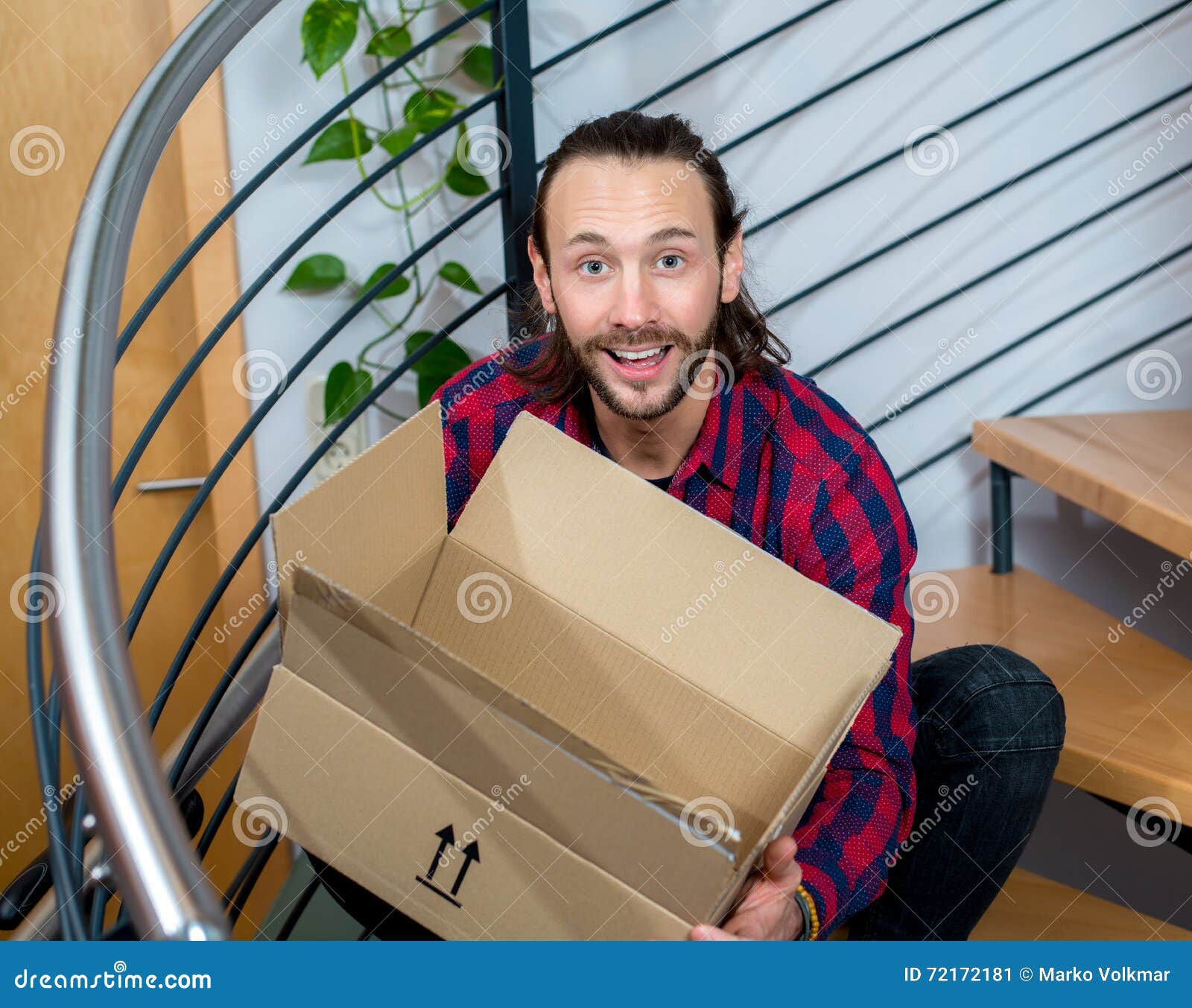 Man Sitting in Corridor and Opening a Package Stock Image - Image of ...
