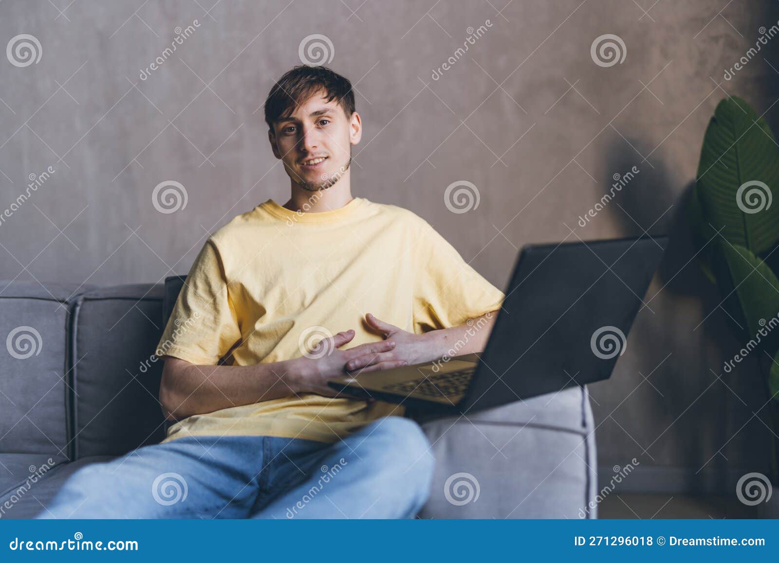 Young Man Sitting on Couch with Laptop Stock Photo - Image of happy ...