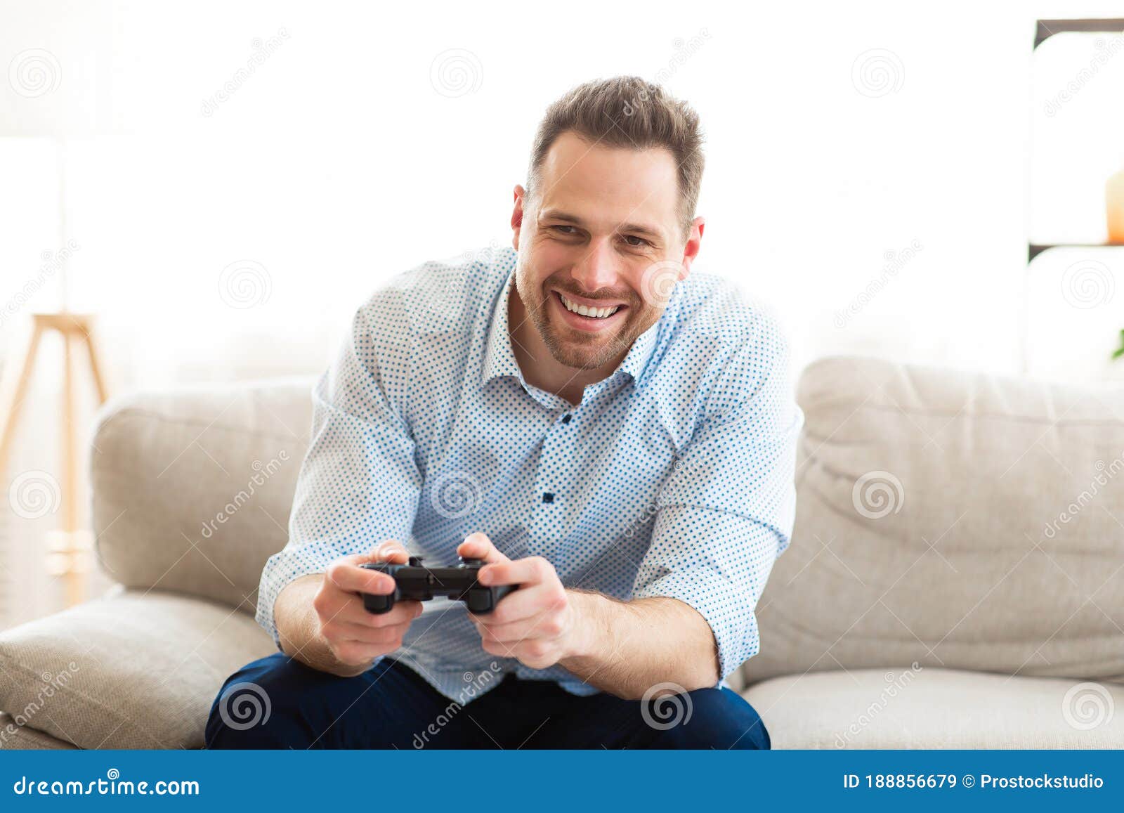 Man Sitting on Couch Playing Video Games Online Stock Image - Image of ...