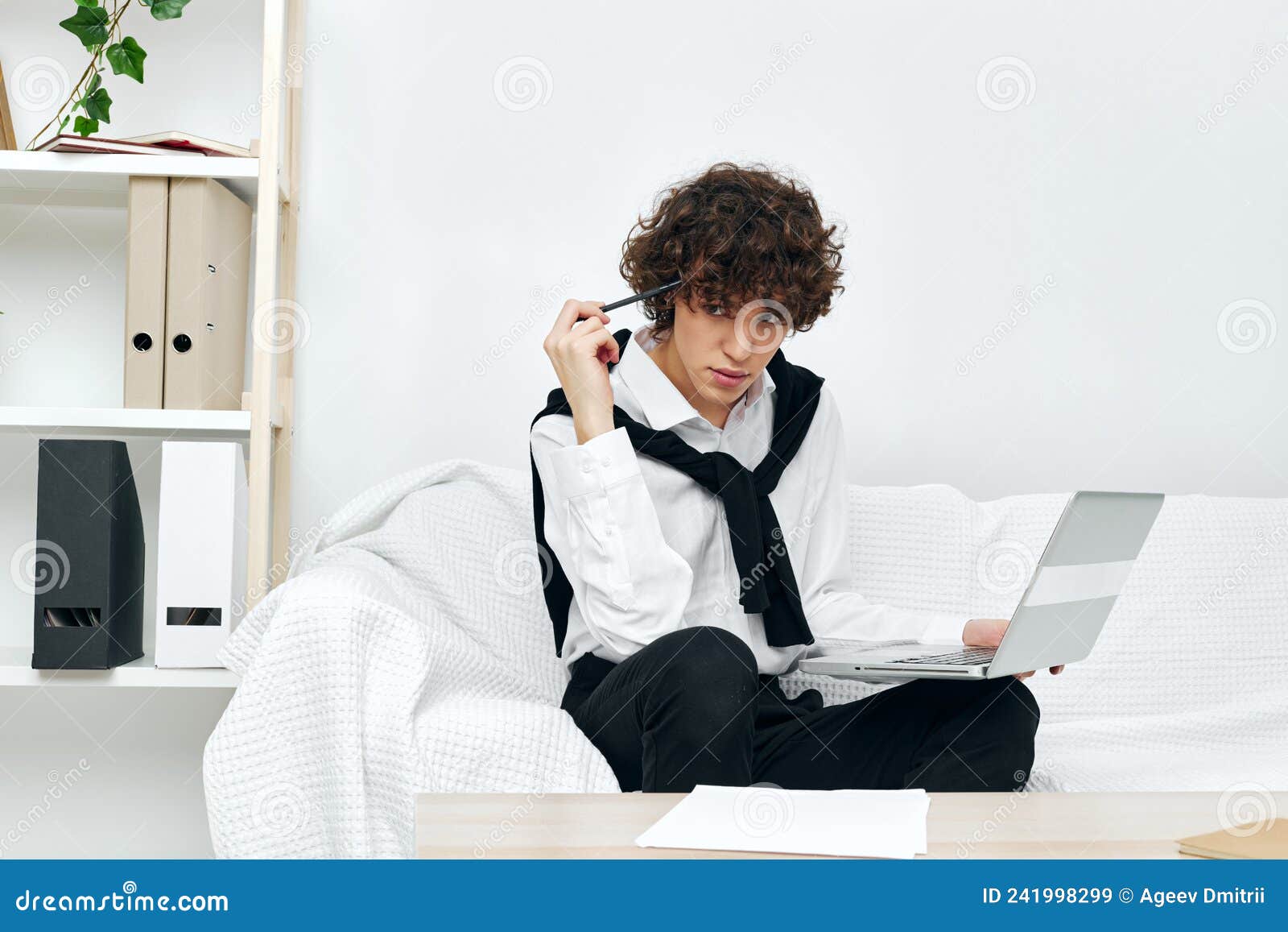 Man Sitting on the Couch at the Table in Front of a Laptop ...