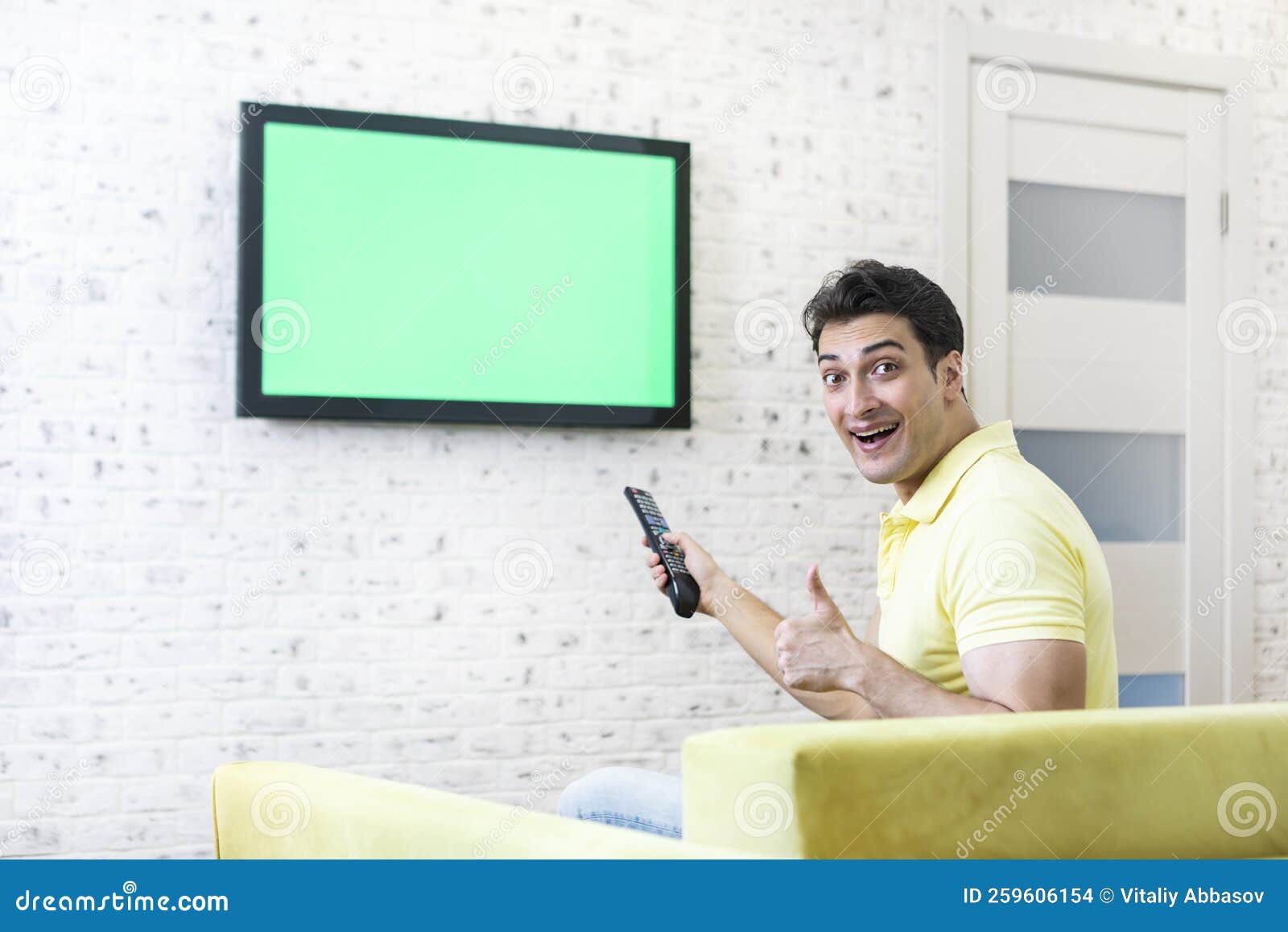 Man Sitting on the Couch, Watching Tv and Showing Thumbs Up Stock Photo ... Man Sitting on the Couch, Watching Tv and Showing Thumbs Up Stock Photo ...