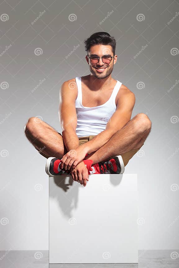 Man Sitting on a Cube and Smiles Stock Image - Image of hand, gray ...