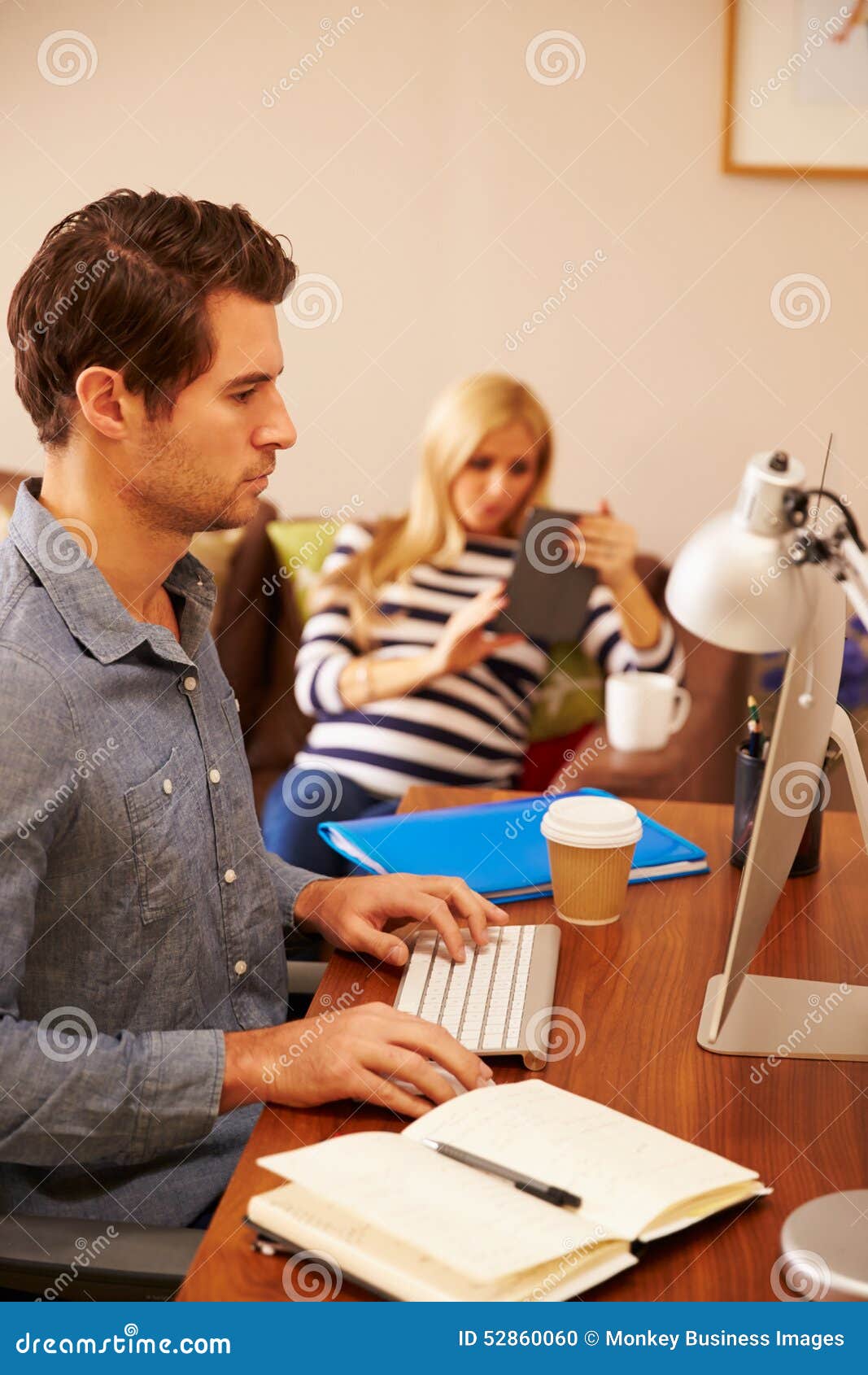 Man Sitting at Desk Working at Computer in Home Office Stock Photo ...