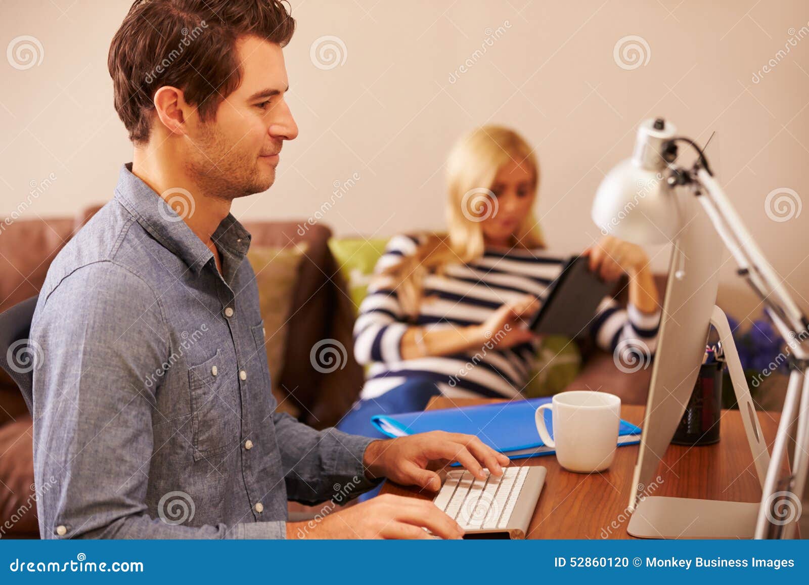 Man Sitting at Desk Working at Computer in Home Office Stock Photo ...