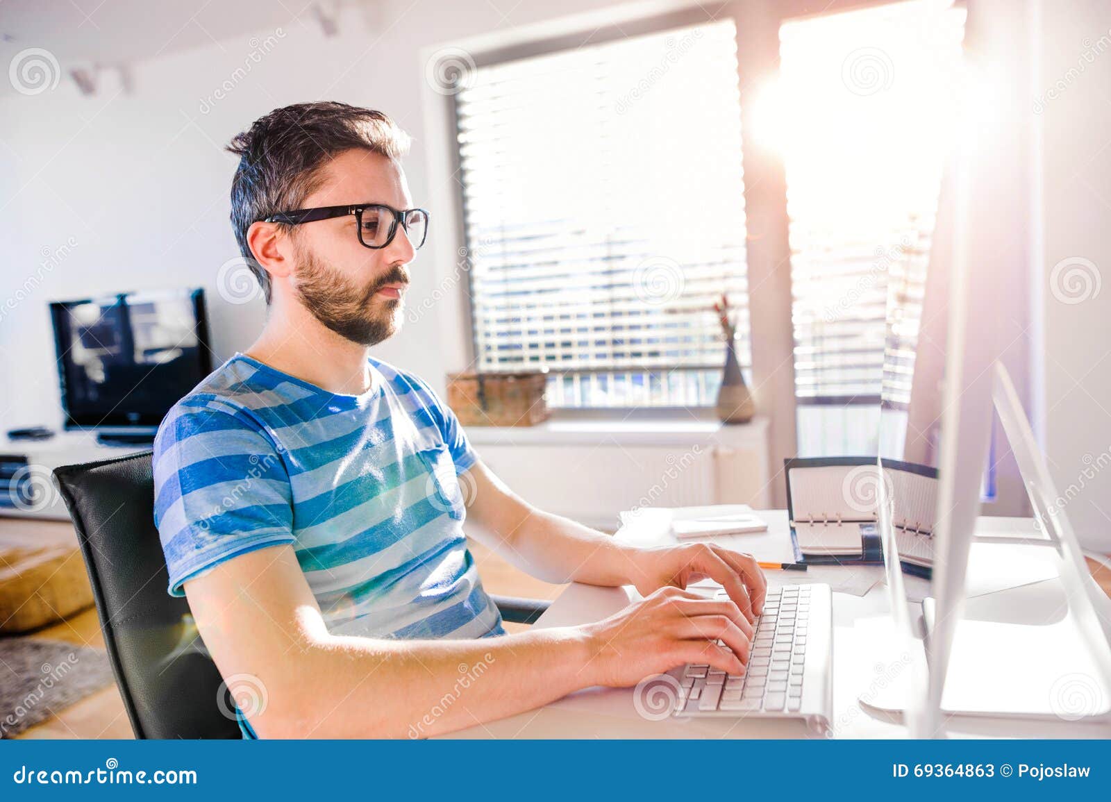 Man Sitting at Desk Working from Home on Computer Stock Image - Image ...