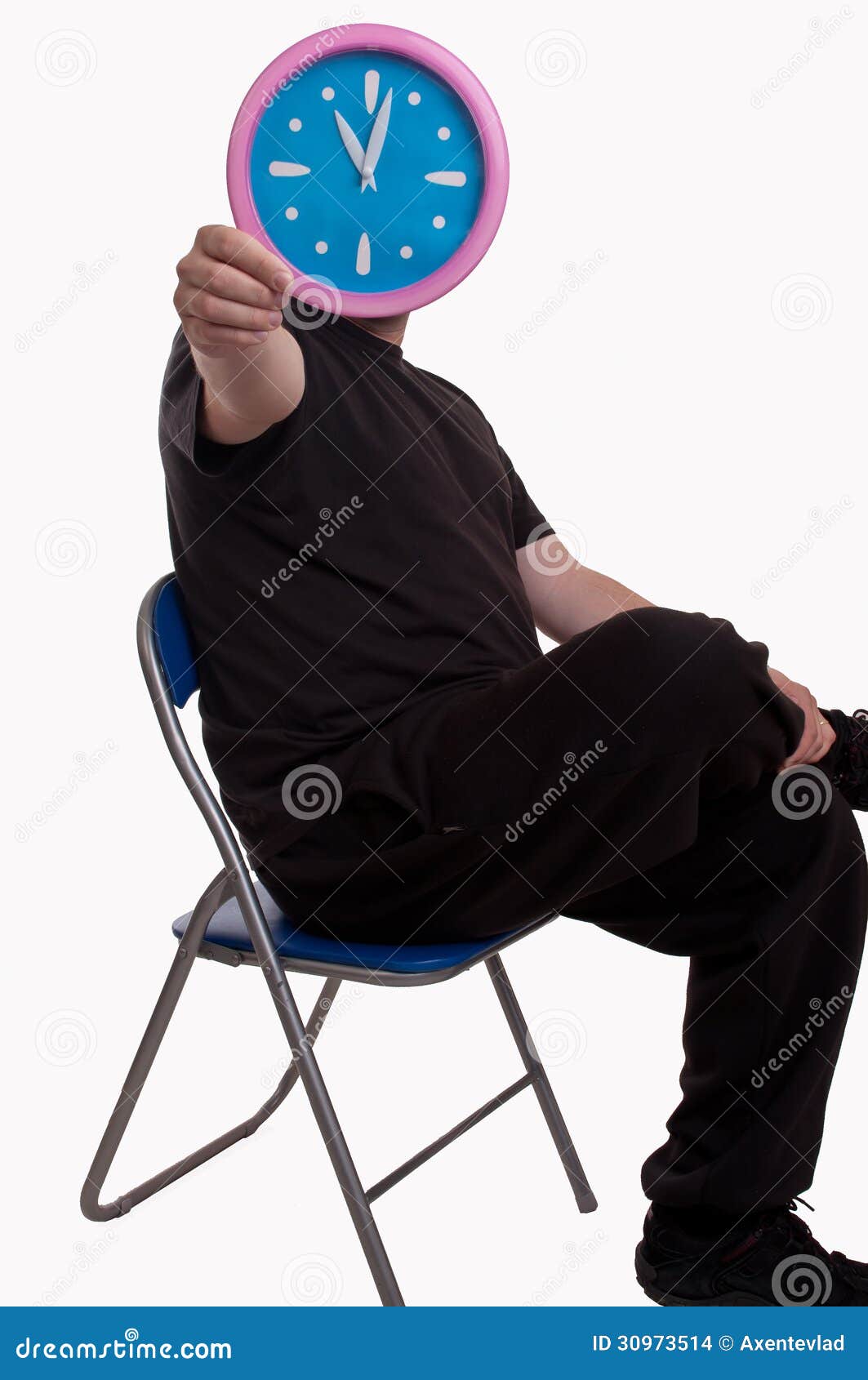 Man Sitting Down on a Chair and Holding in Front of His Face a Large ...