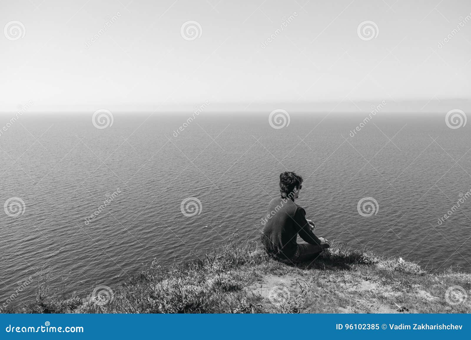 Man Sitting on Edge of Cliff at Edge Stock Image - Image of mountain ...