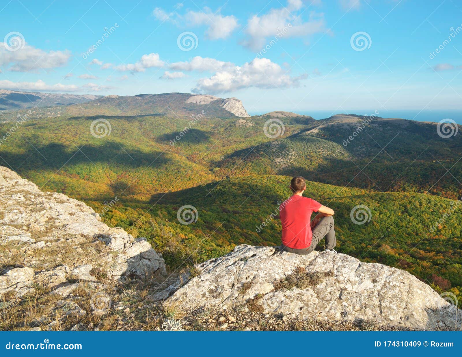 Man Sitting on the Edge of Cliff Mountain Stock Image - Image of ...