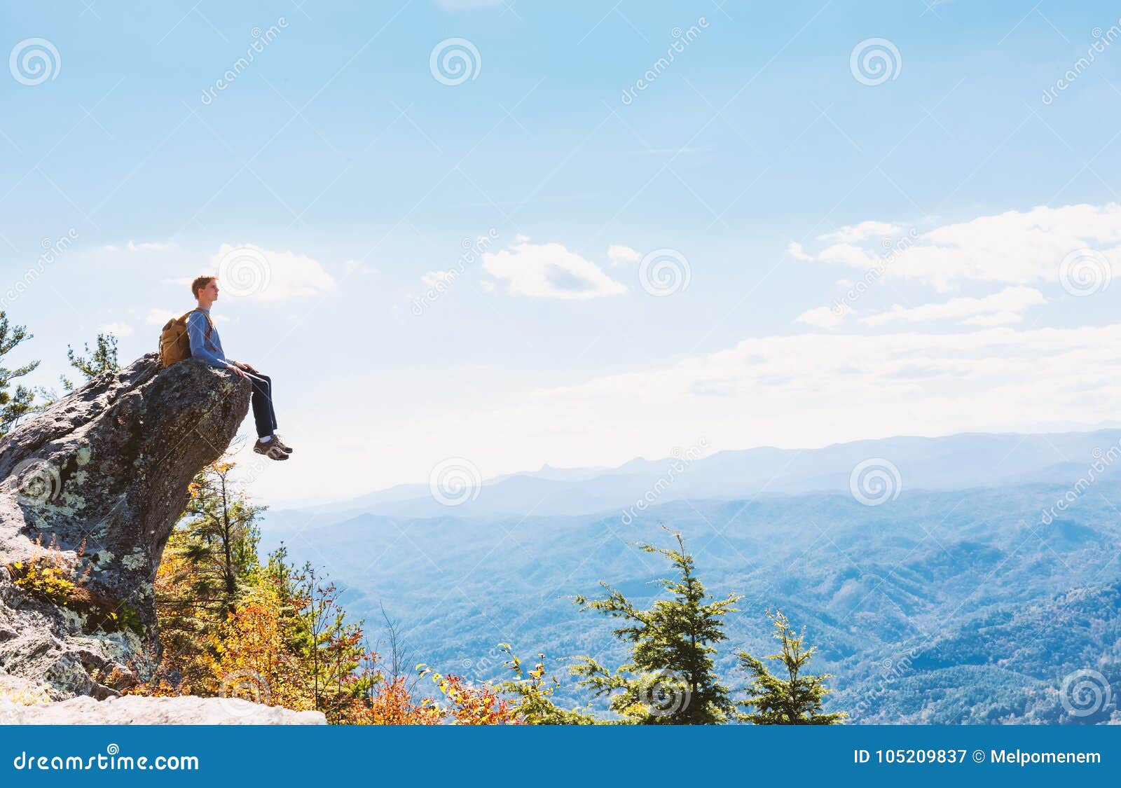 Man Sitting on the Edge of a Cliff Overlooking Stock Image - Image of ...
