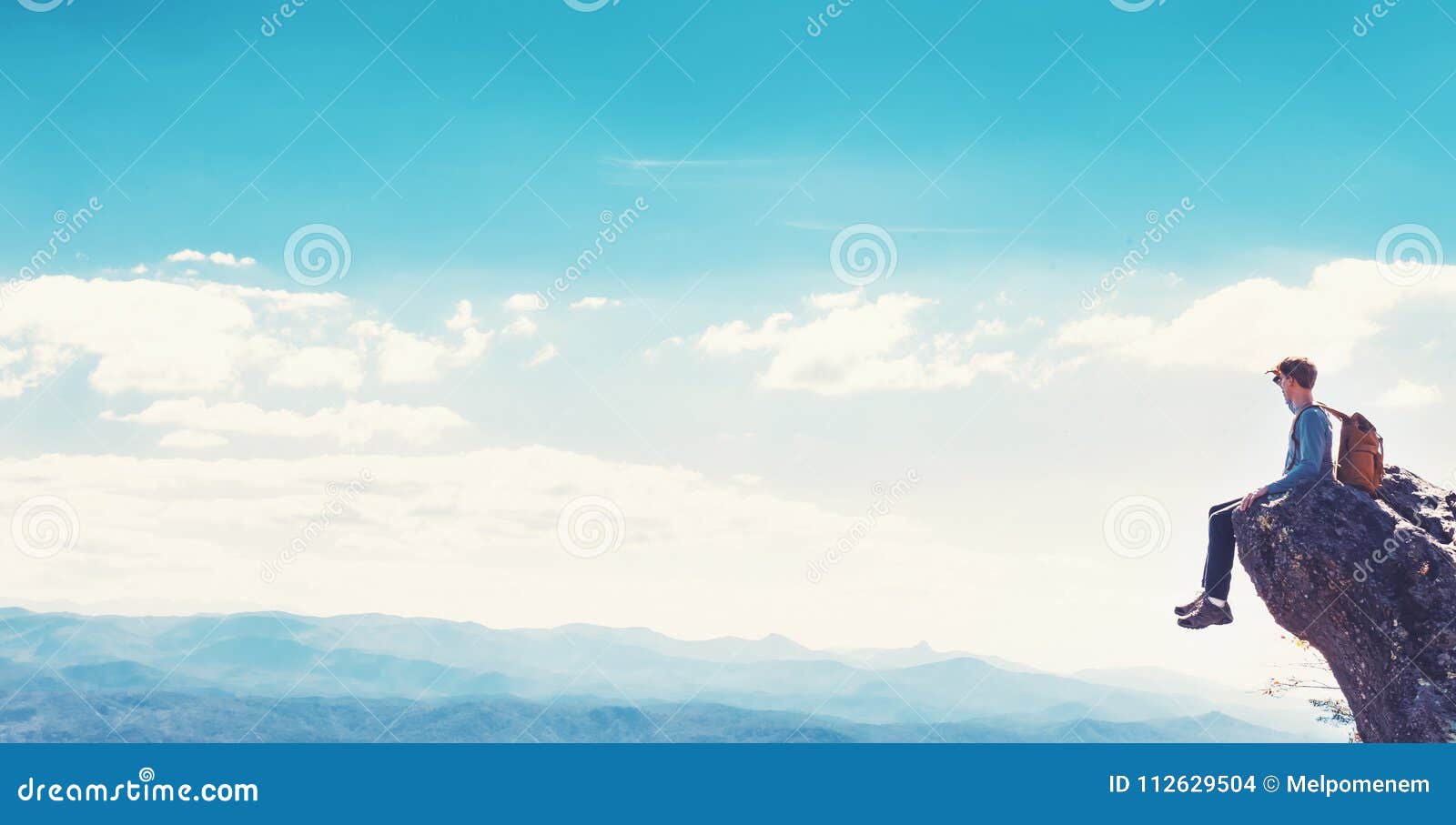 Man Sitting on the Edge of a Cliff Overlooking Stock Photo - Image of ...