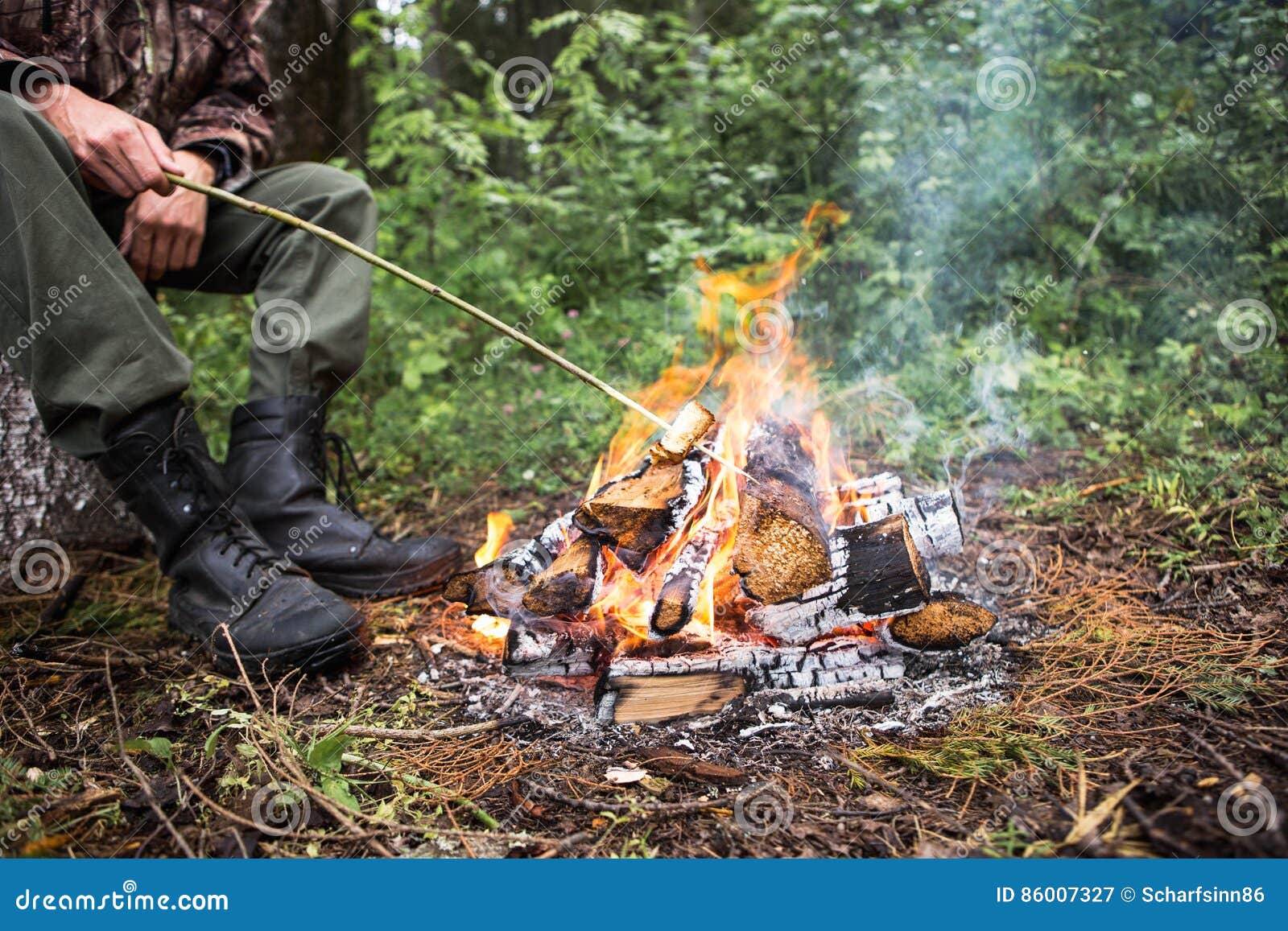 The Man Sitting by the Fire in the Forest. Stock Image - Image of ...