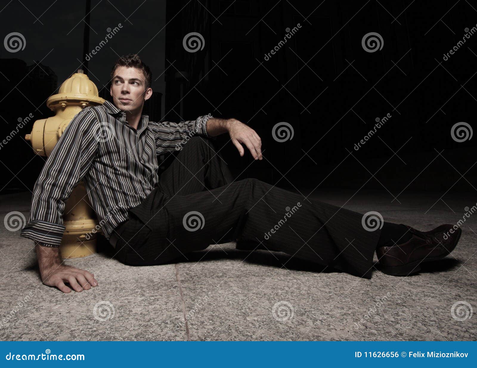 Man Sitting by a Fire Hydrant Stock Photo - Image of unemployed ...