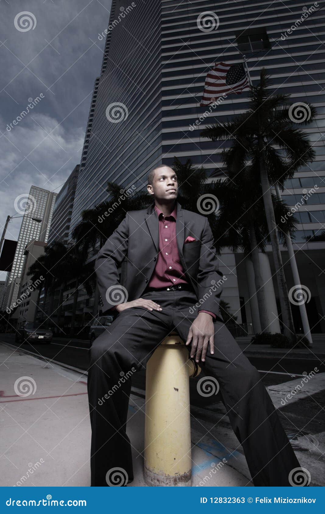 Man Sitting on a Fire Hydrant Stock Image - Image of african, hydrant ...