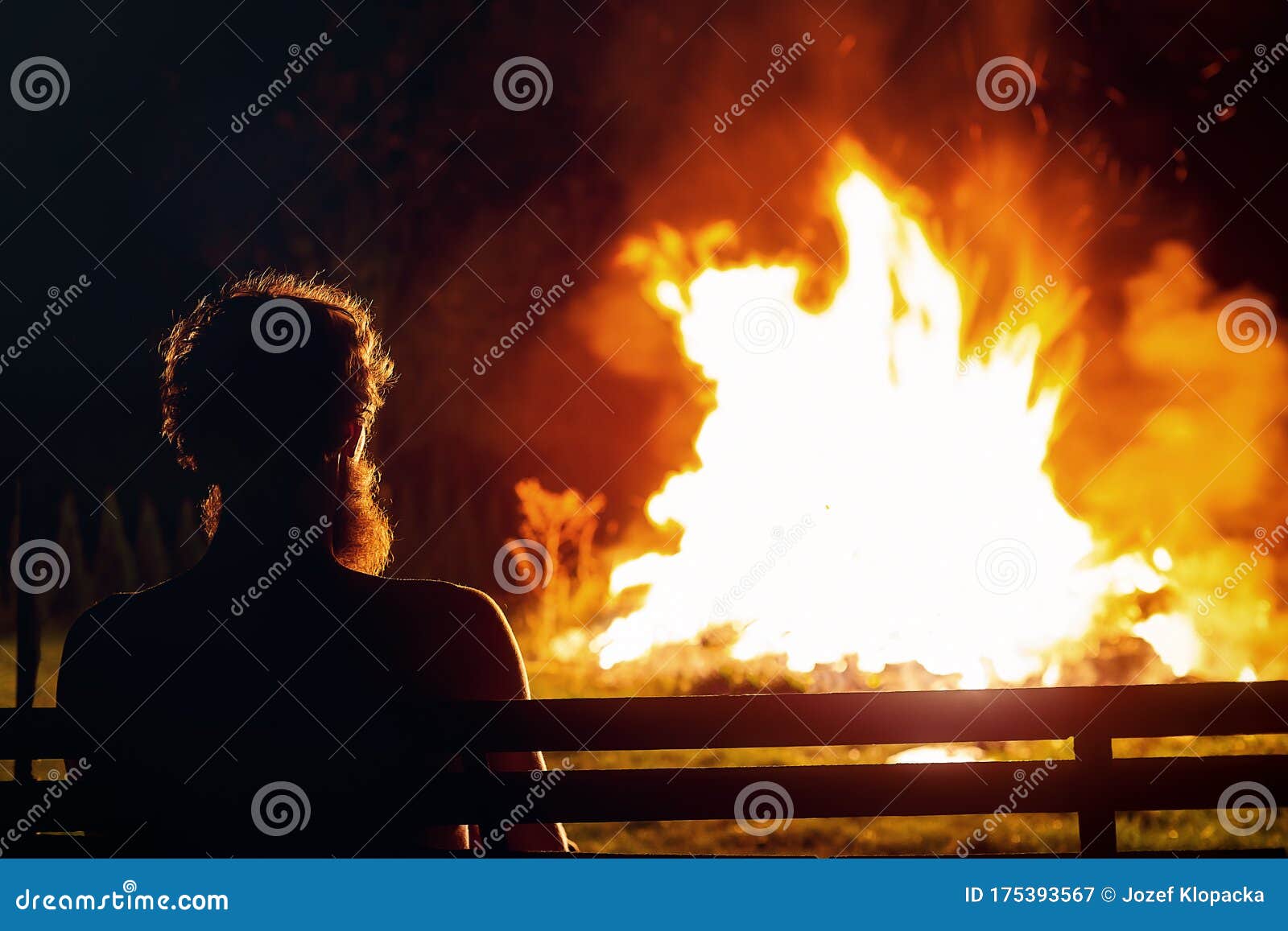 Man Sitting by the Fire and Looking To the Flame. Stock Image - Image ...