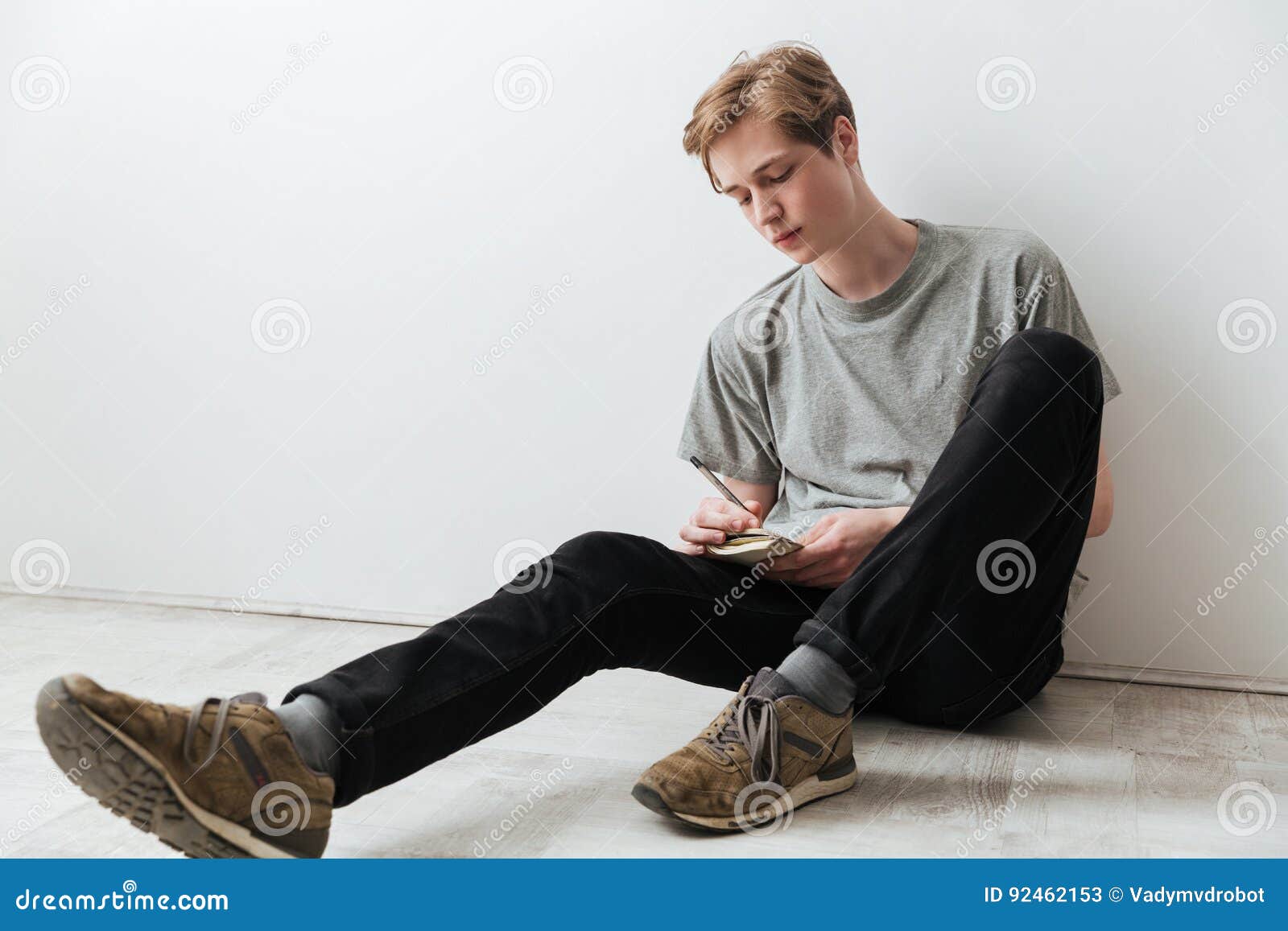 Man Sitting on the Floor and Writing Something Stock Image - Image of ...
