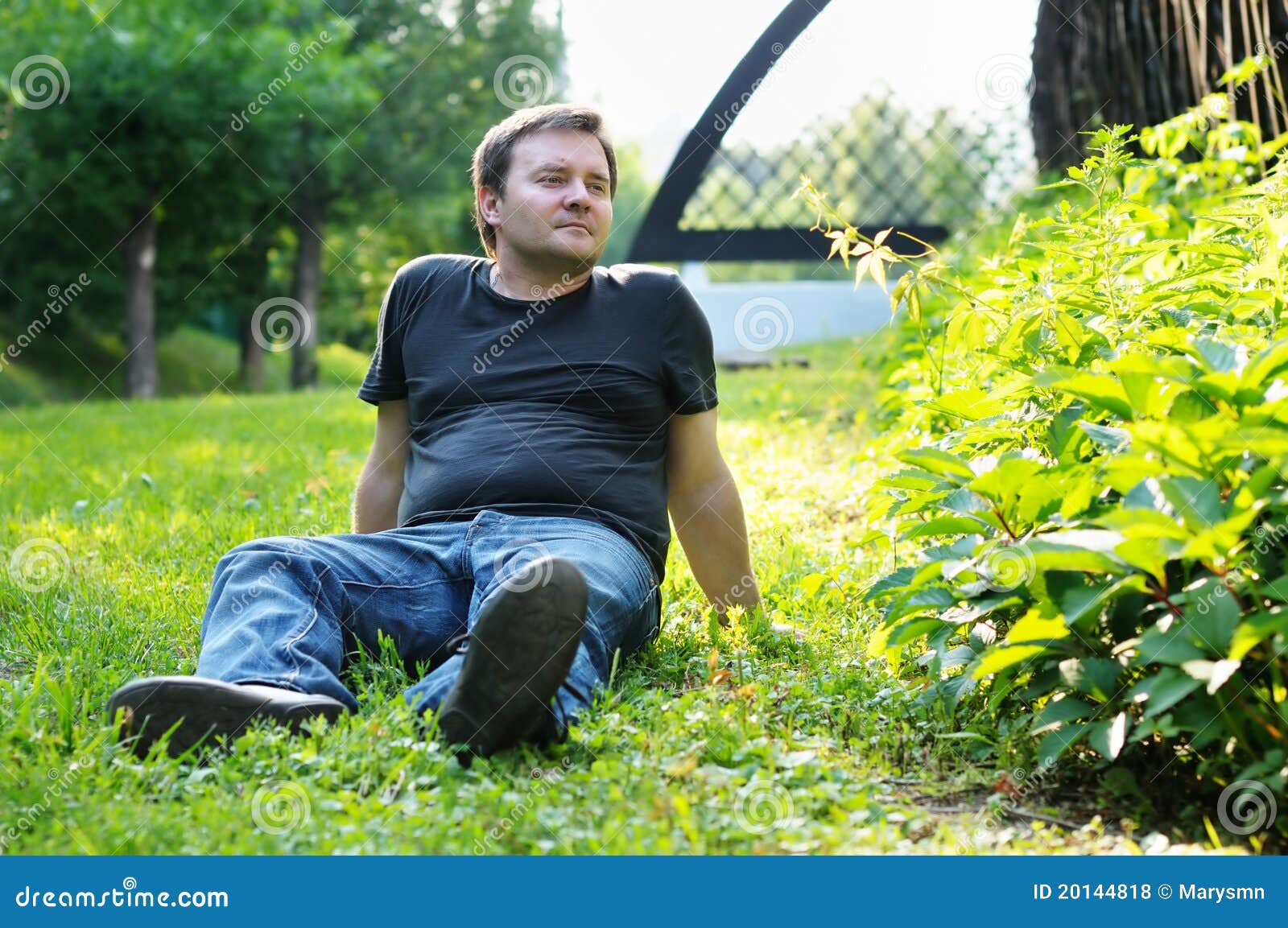 Man sitting on the grass stock photo. Image of cheerful - 20144818