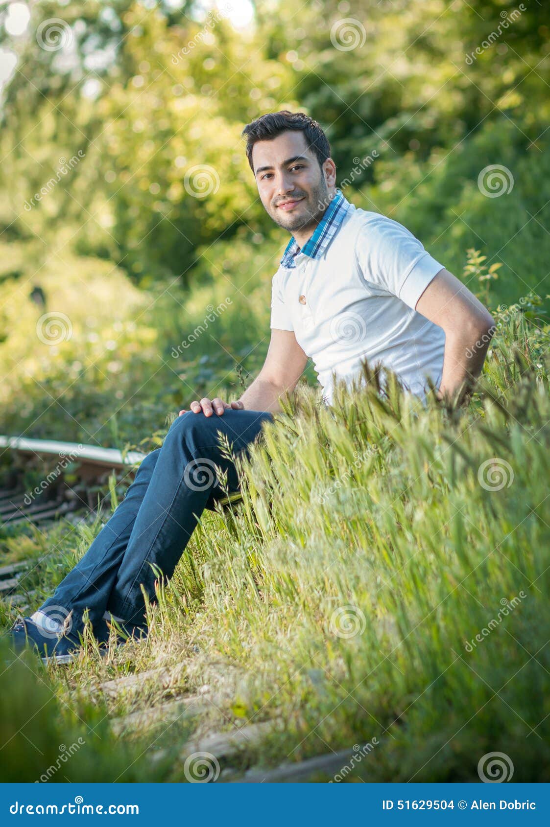 Man Sitting on Grass in Forest Stock Photo - Image of outdoors, summer ...