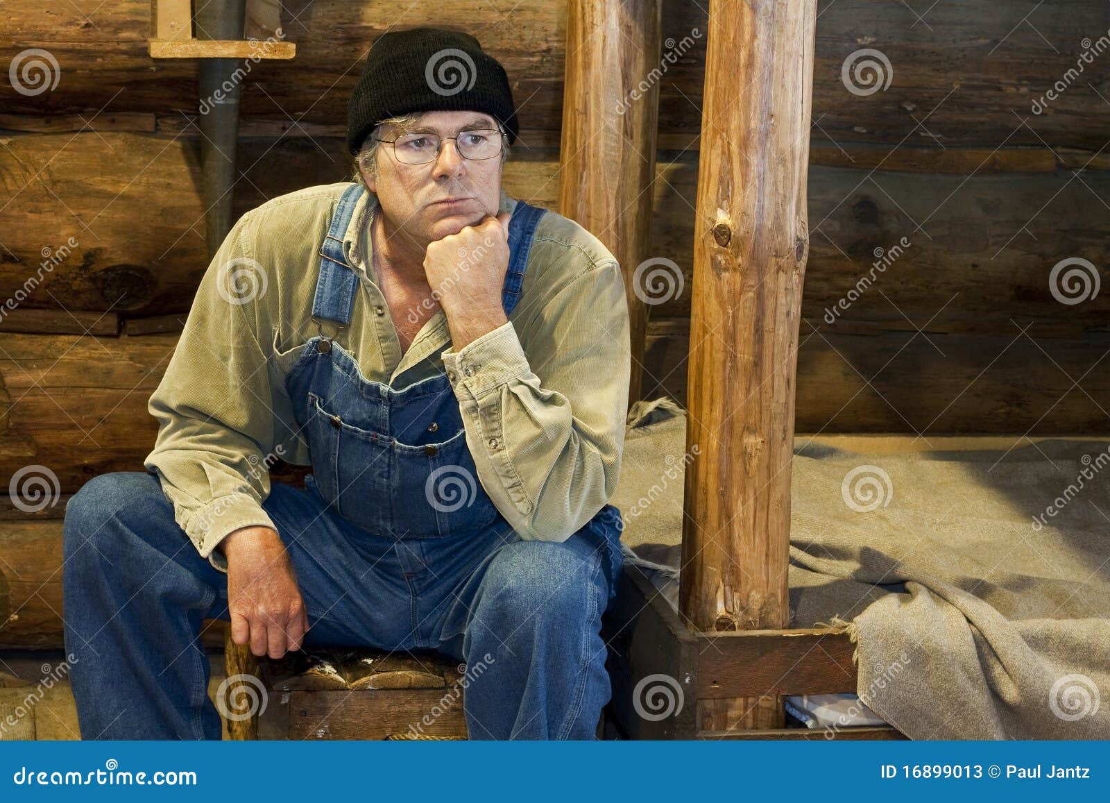 Man Sitting In His Log Cabin Thinking Stock Photos - Image: 16899013