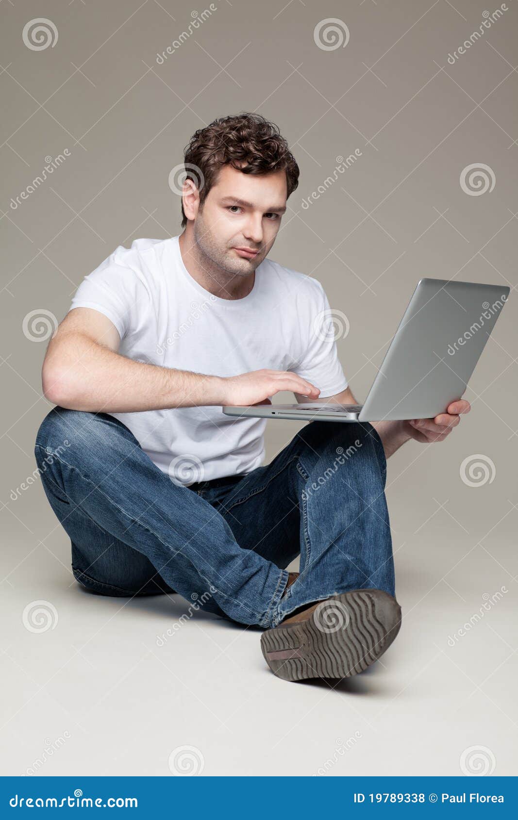 Man Sitting and Holding Laptop Stock Photo - Image of smile, searching ...