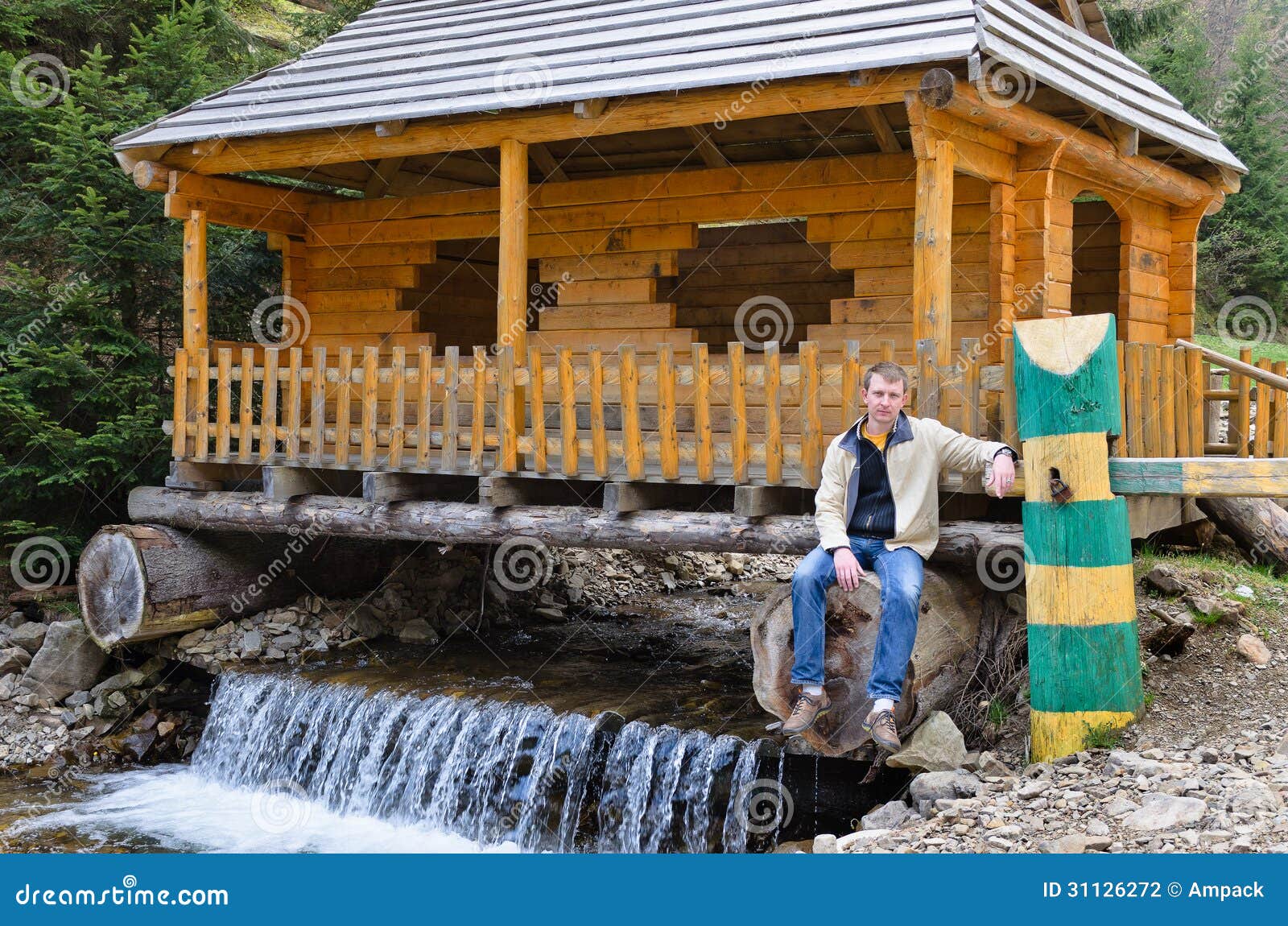 Man sitting at a hut built stock photo. Image of person - 31126272