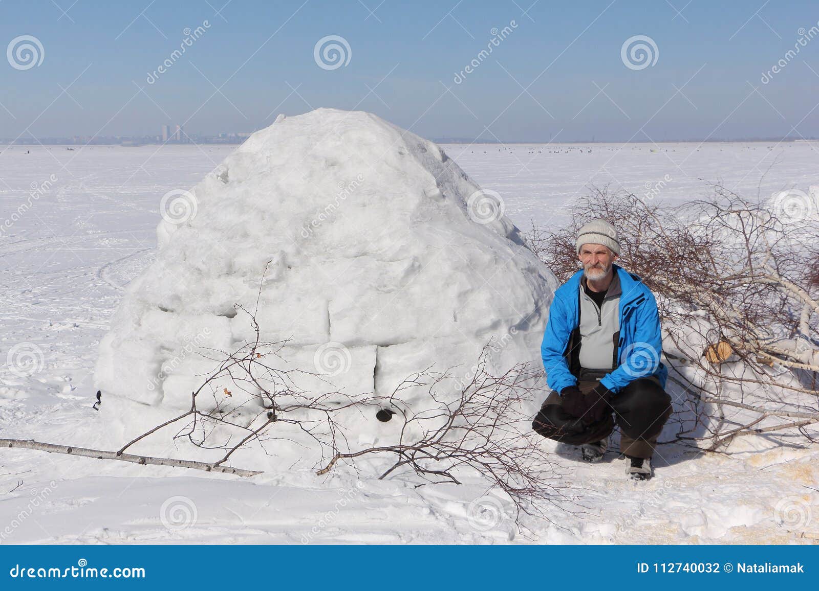 Man Sitting by an Igloo on a Glade in the Winter Stock Photo - Image of ...